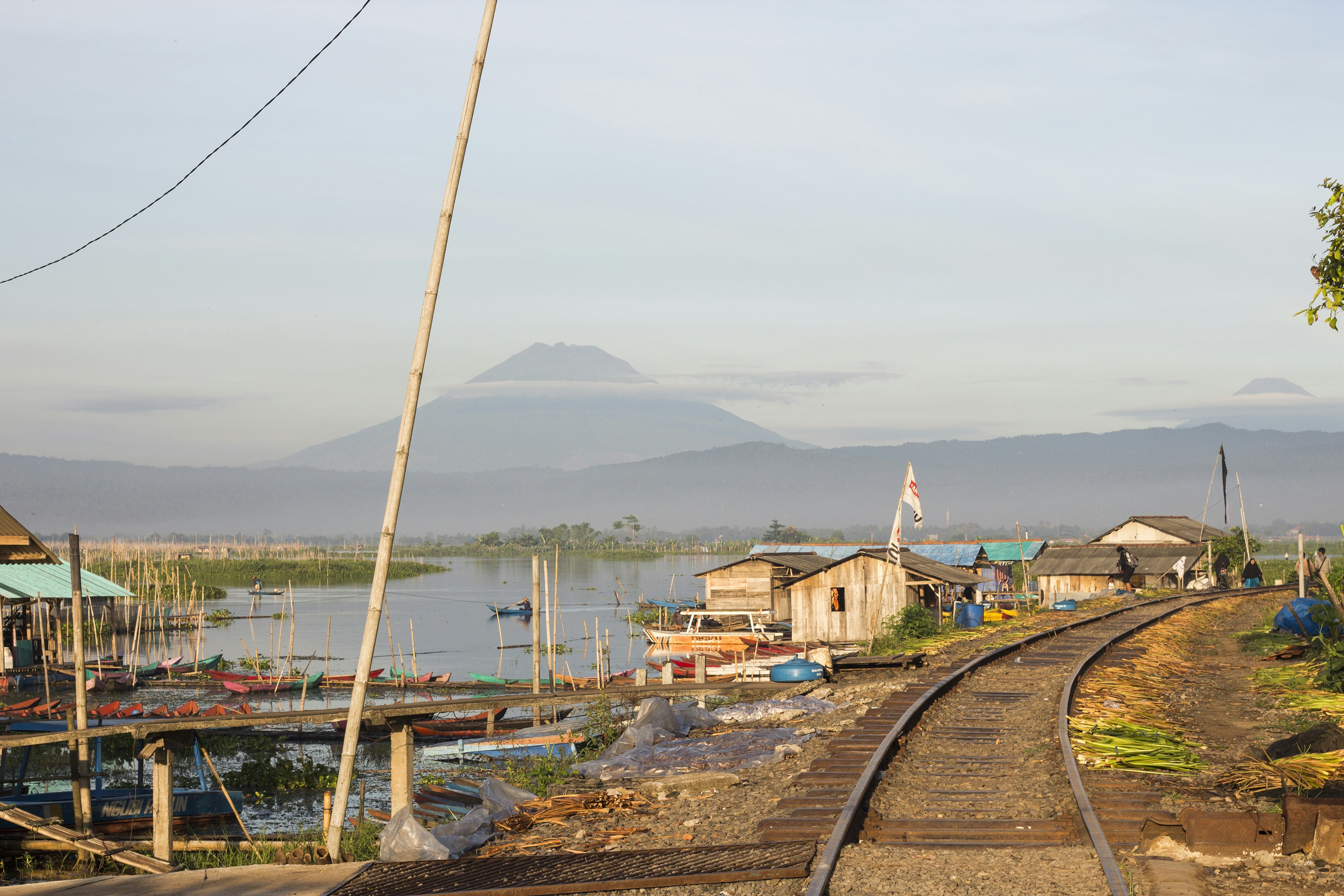 Ridge and Rails: A Quiet Lakeside Rail Bends Toward Dawn