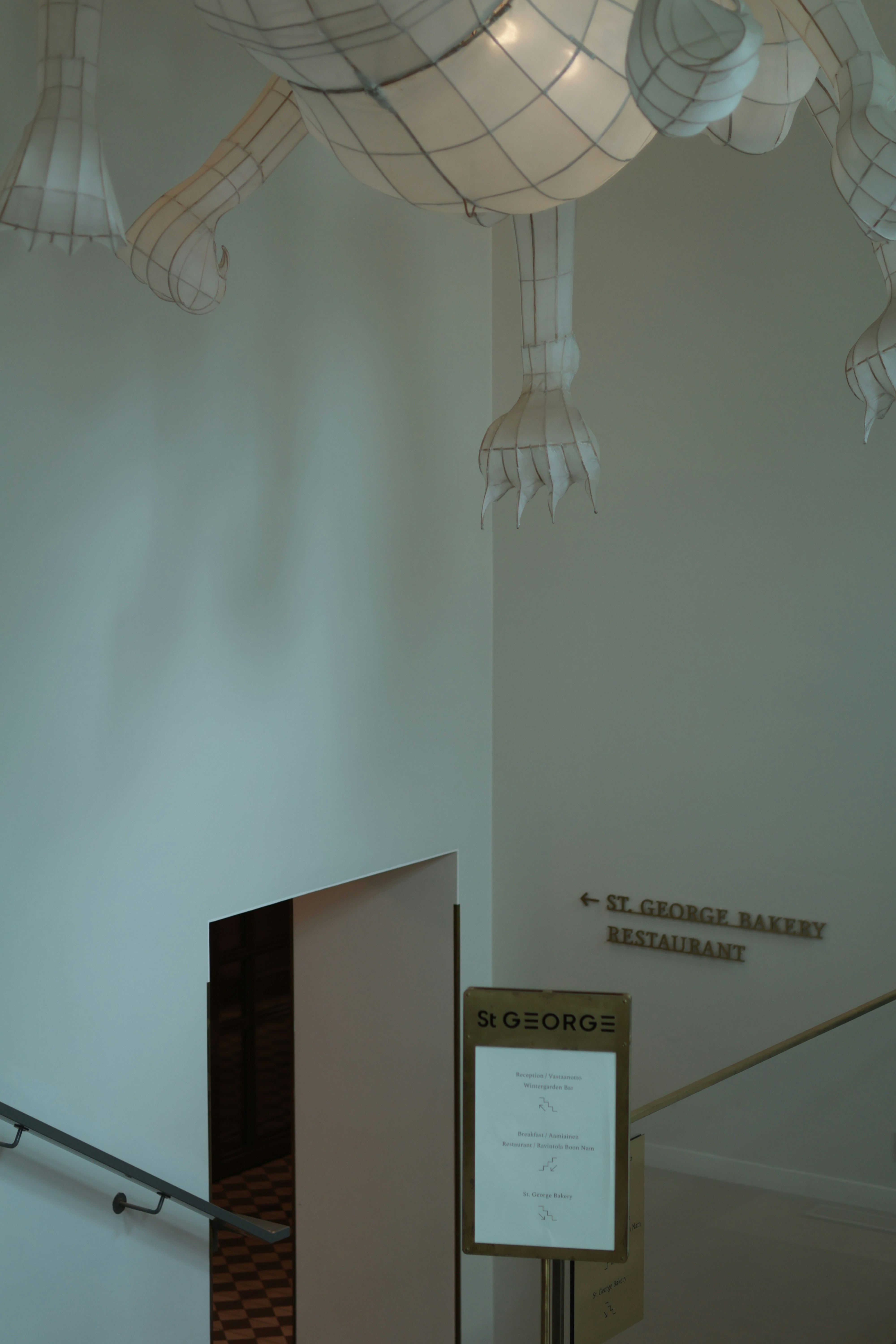 Whimsical Lamps Loom Over a Quiet Museum Entrance