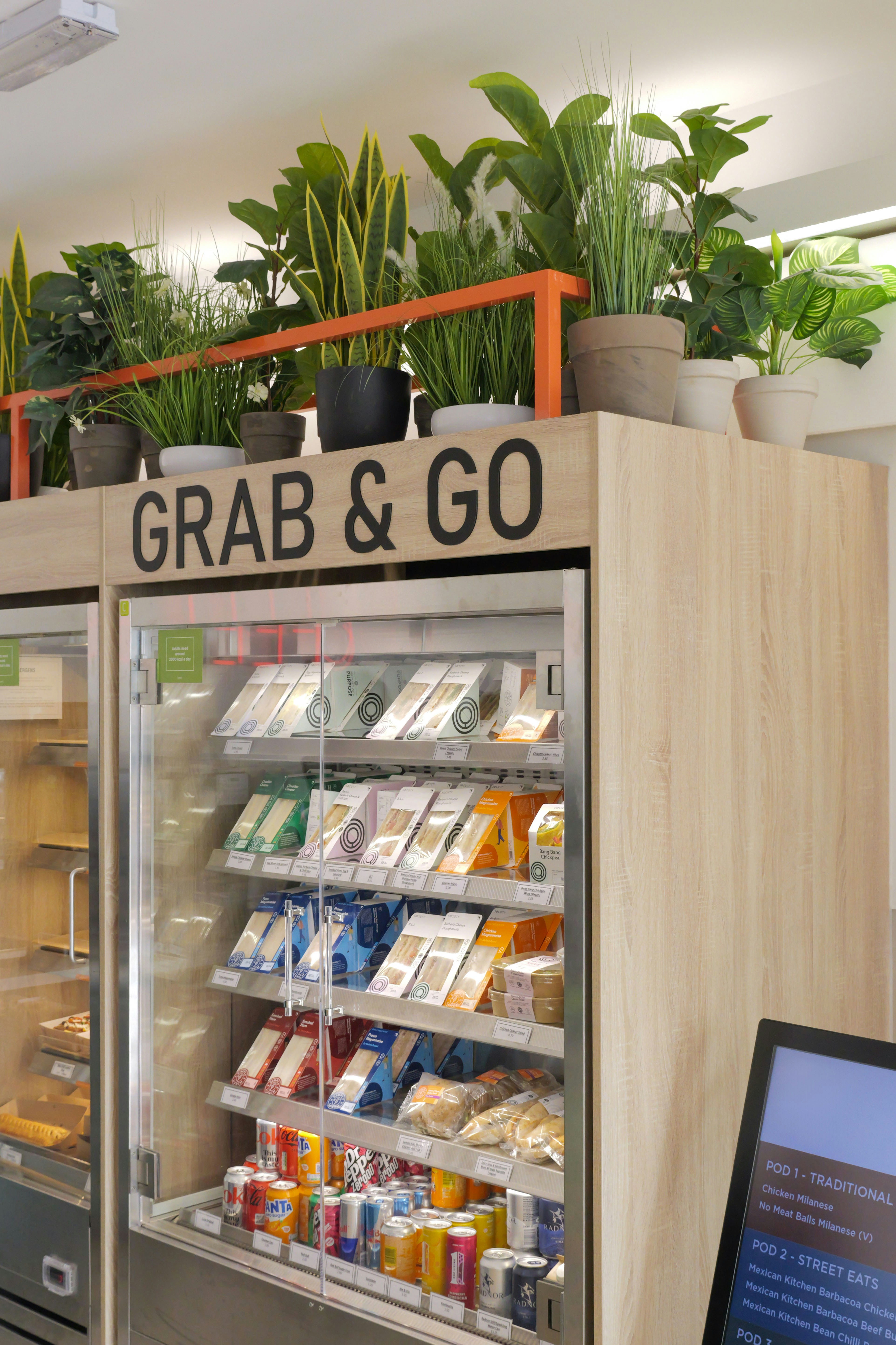 Greenery Over Aisle: A Modern Grab & Go Shelf Surrounded by Plants