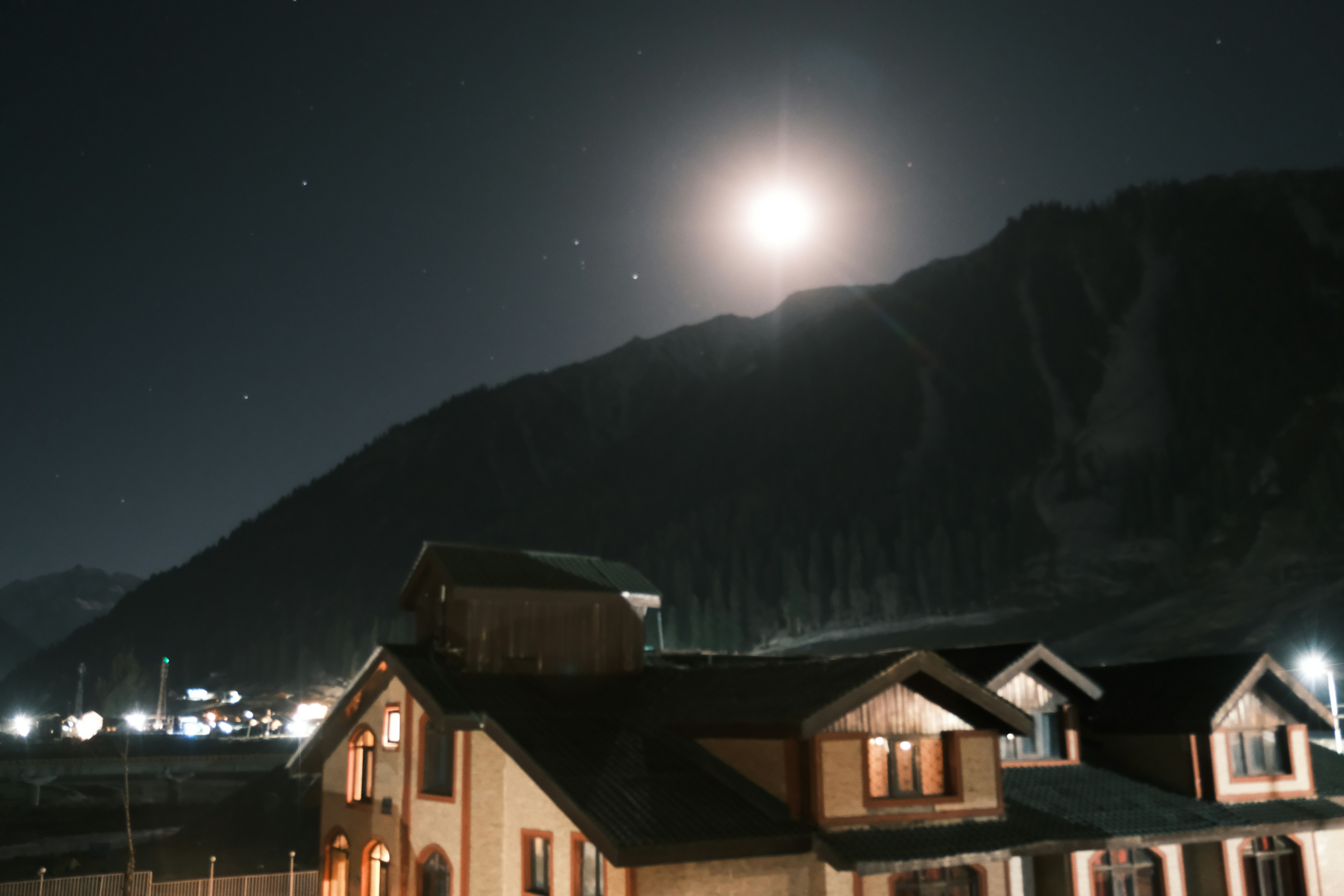 Moonlit Village Over Snowy Ridge