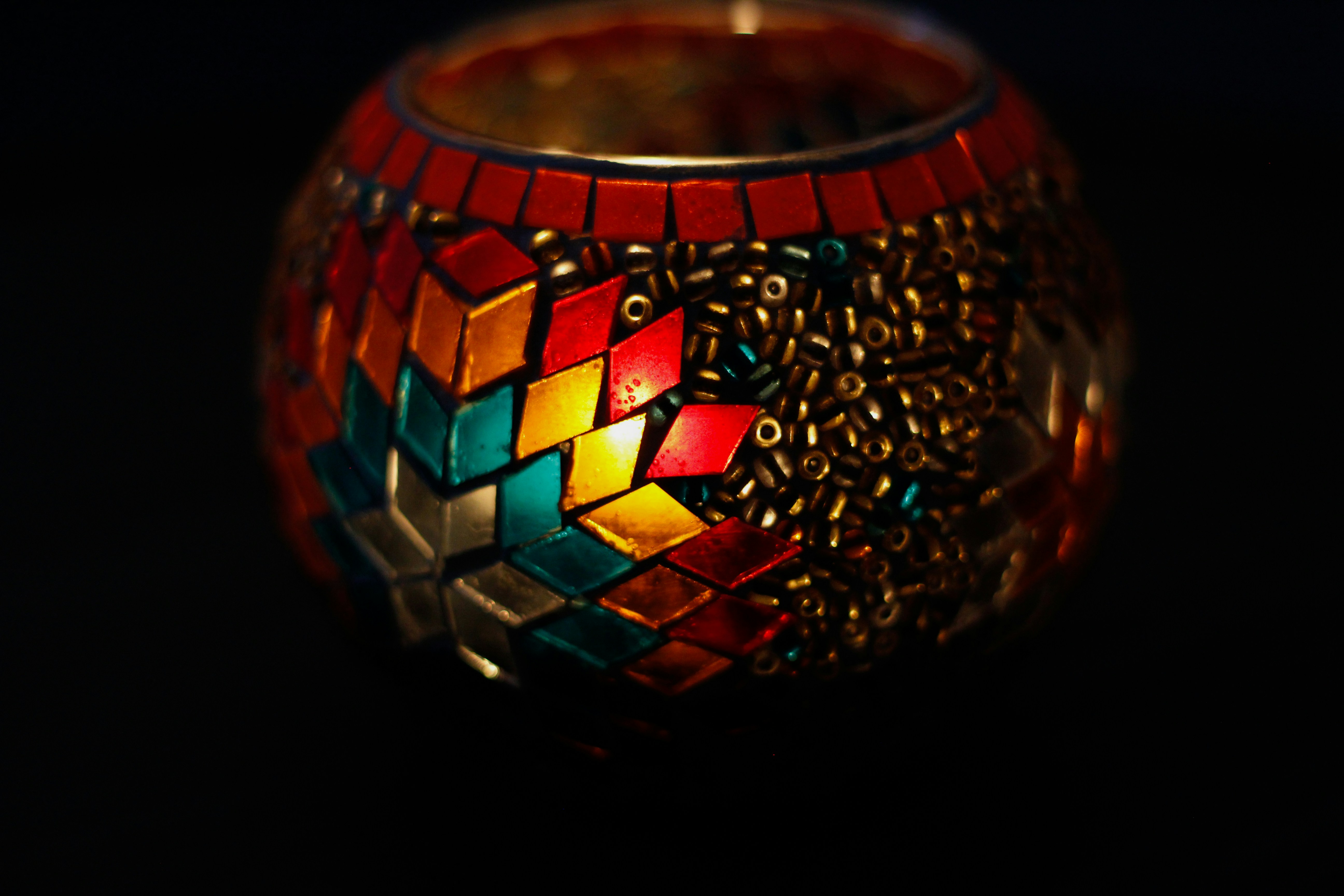 Color mosaic in a dim-lit glass vessel
