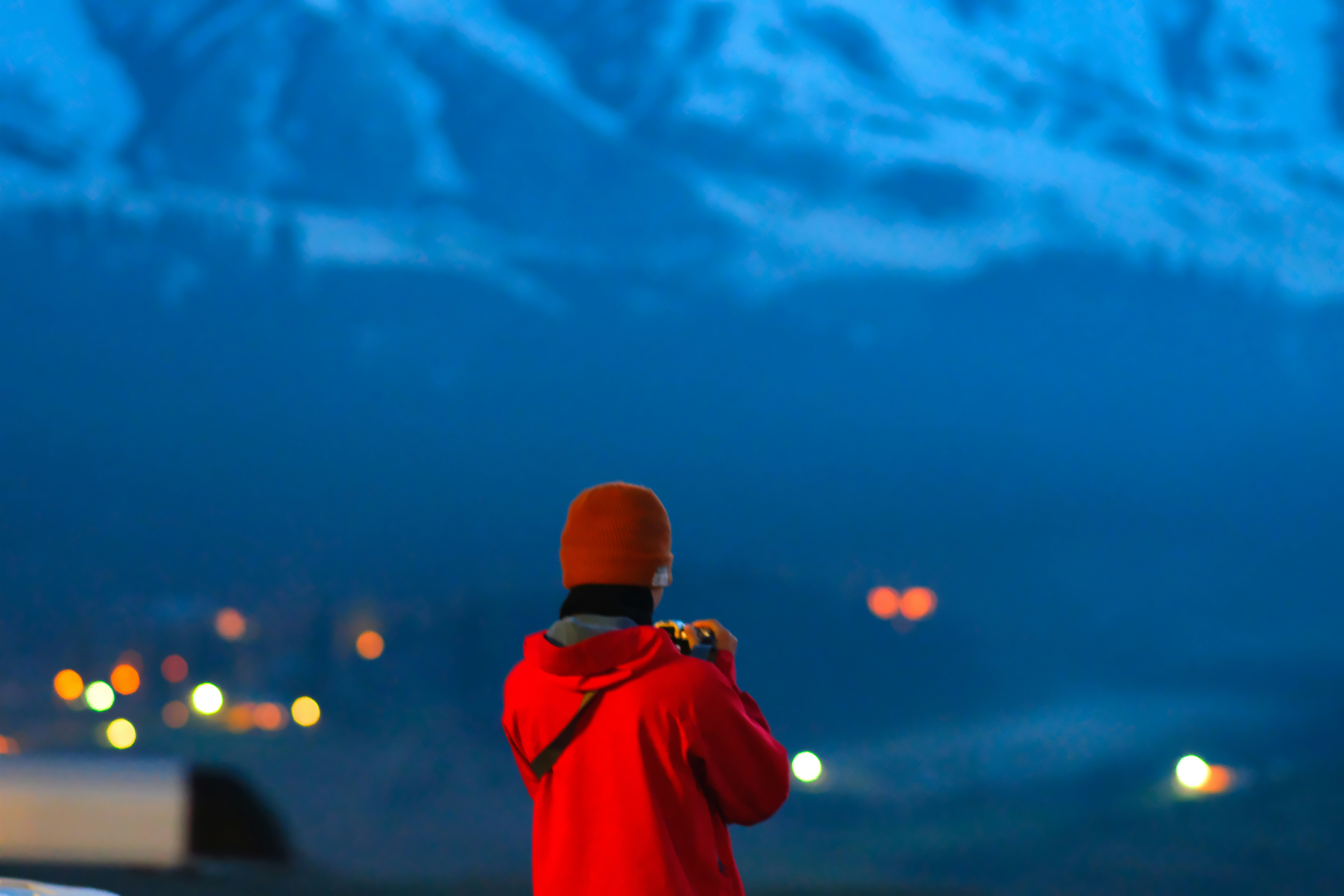 Red Jacket at Dusk: a Quiet Portrait with a Cityscape Backdrop