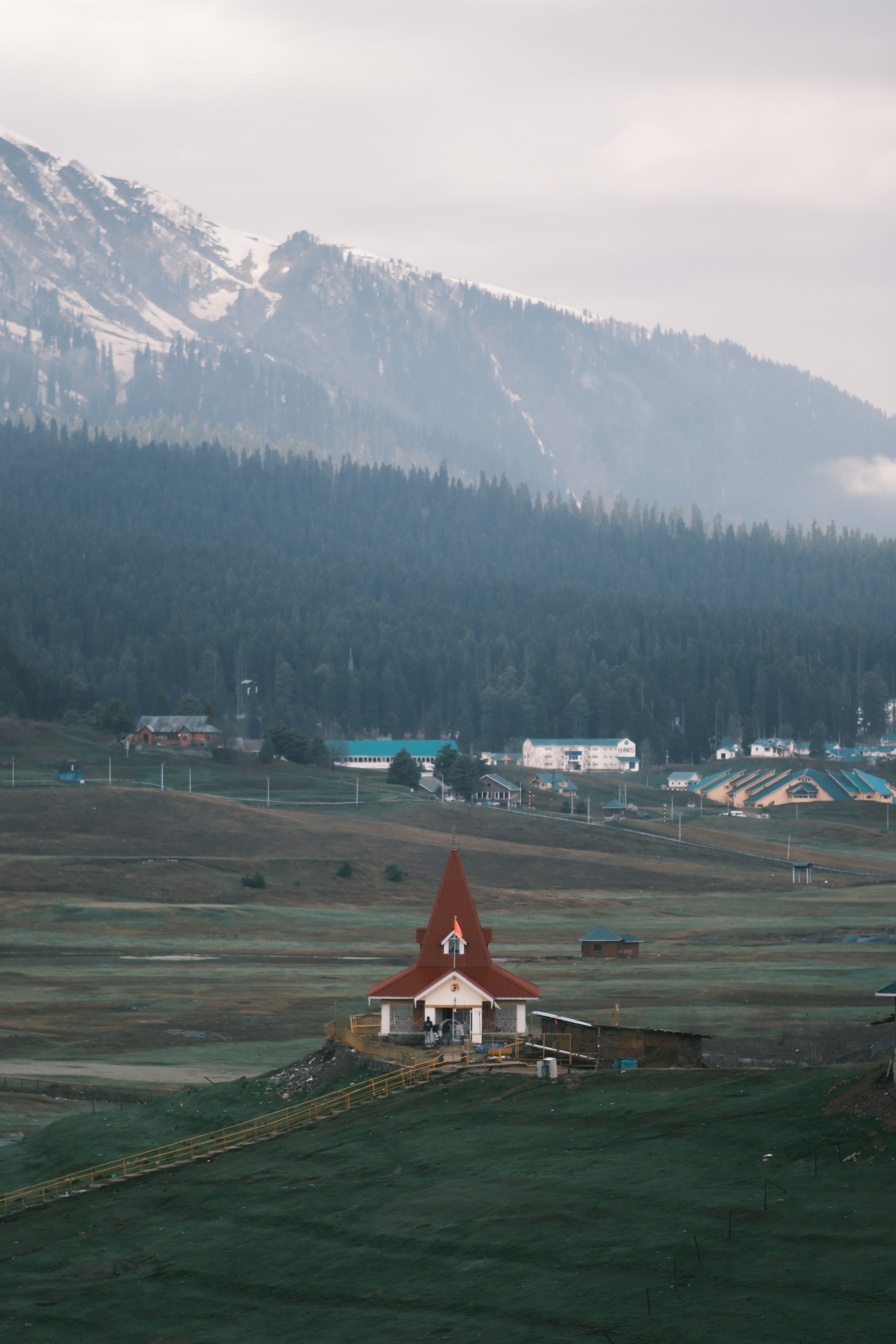 Red-roofed Chapel in a Misty Mountain Valley