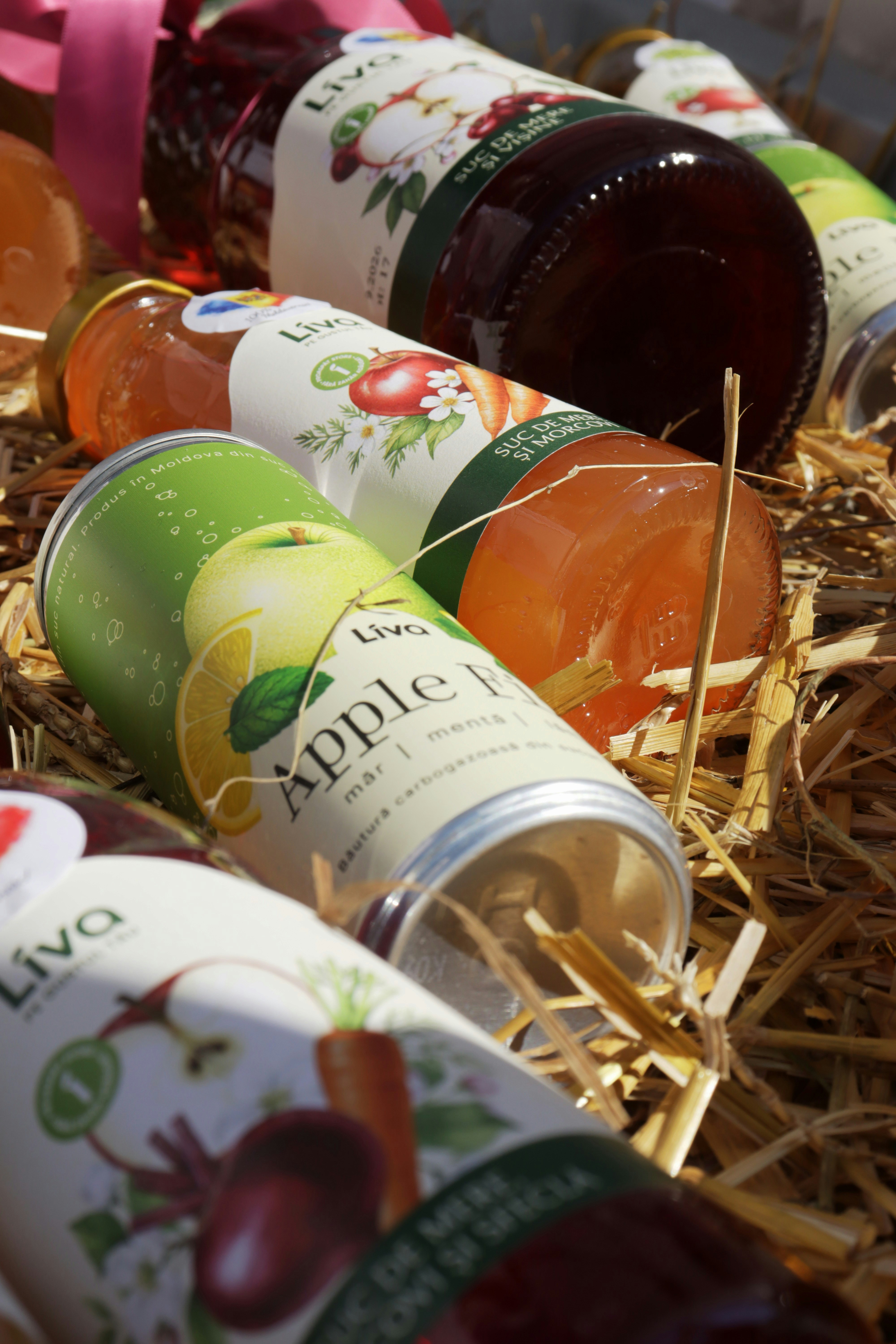 Sunlit Orchard Elixirs: Apple-Fruit Bottles Resting in Straw