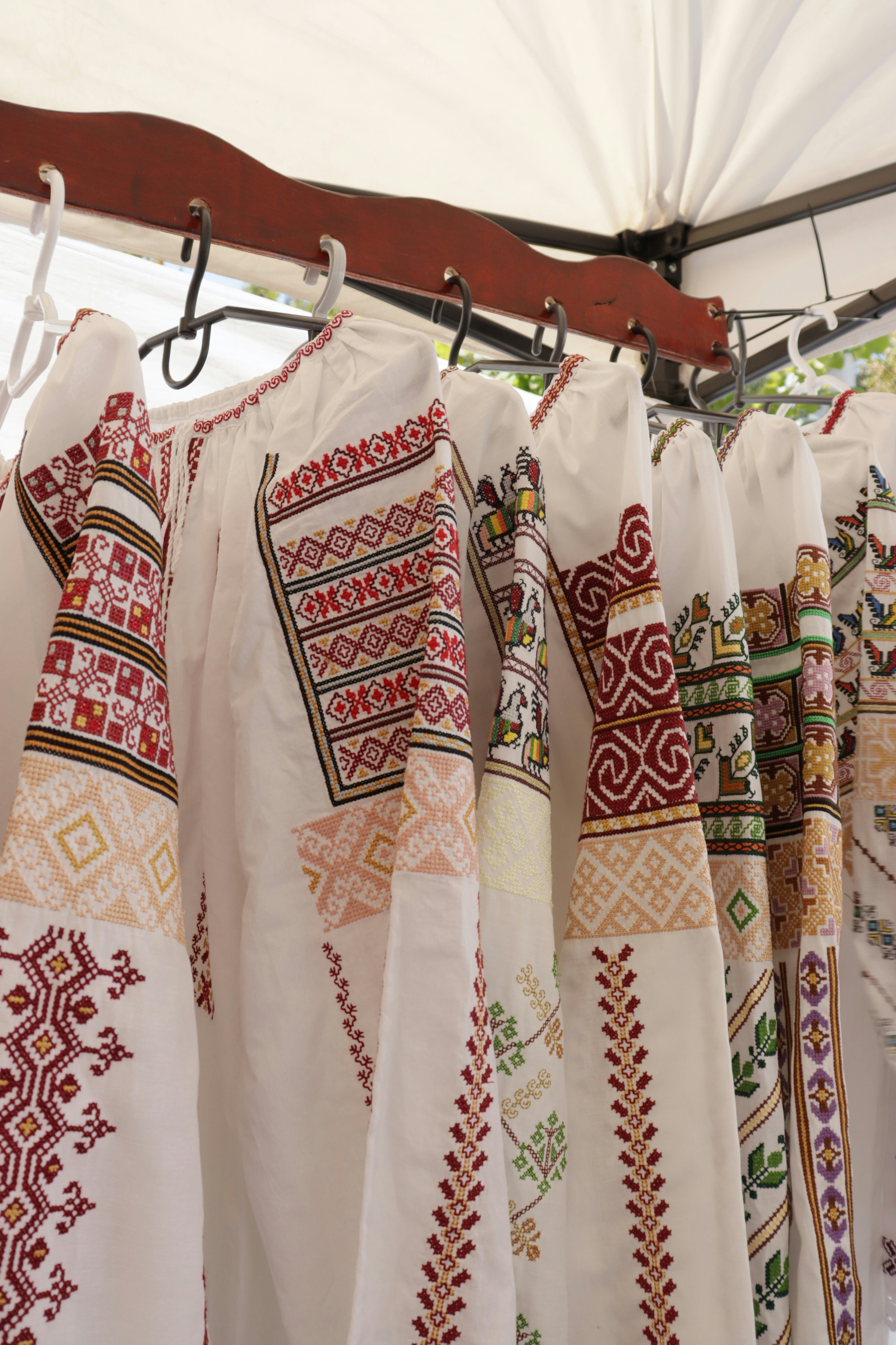 Hanging Threads: Traditional Embroidery Dresses on a Rack