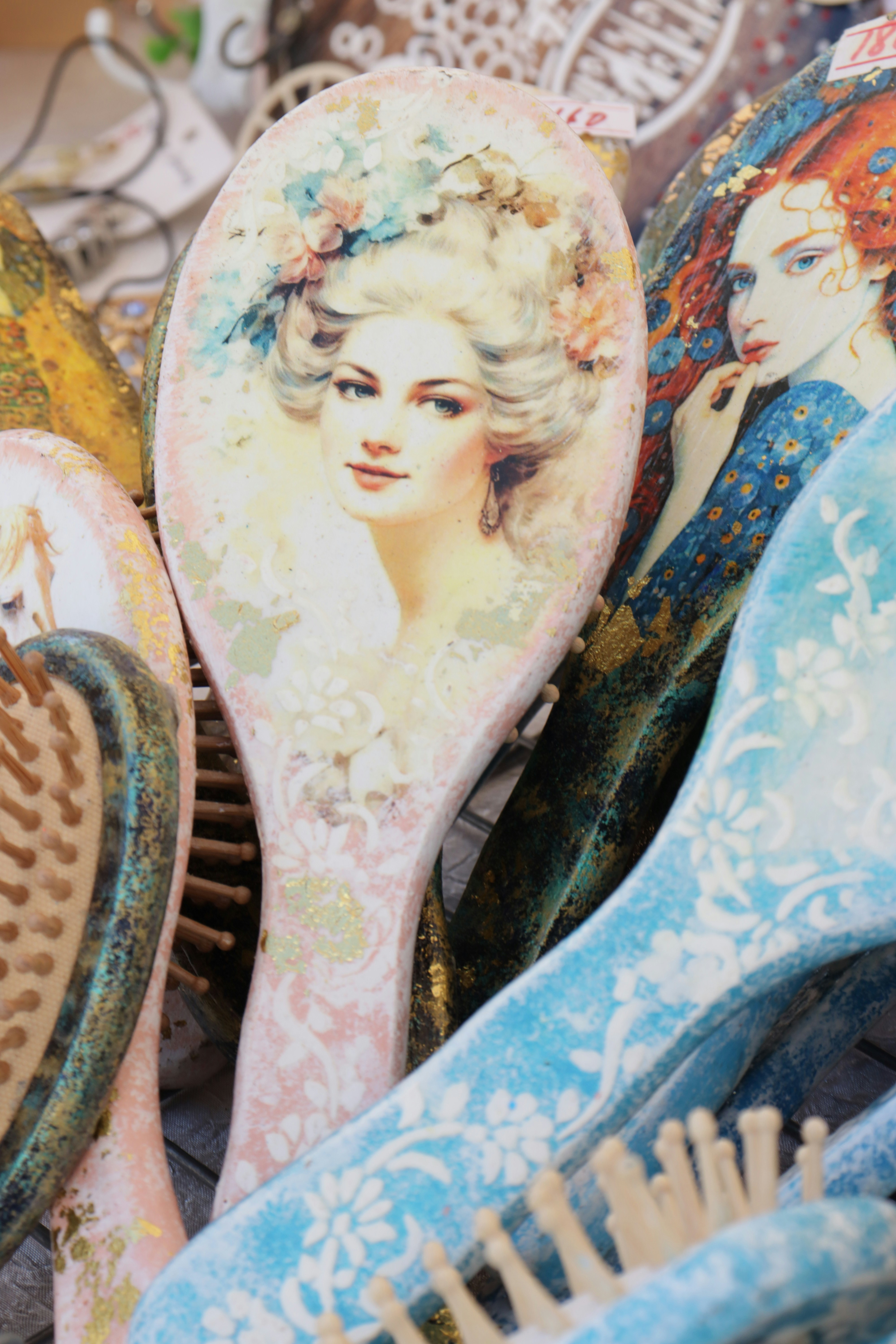 Portrait cameo on pastel parasol: vintage ladies smile from painted wood