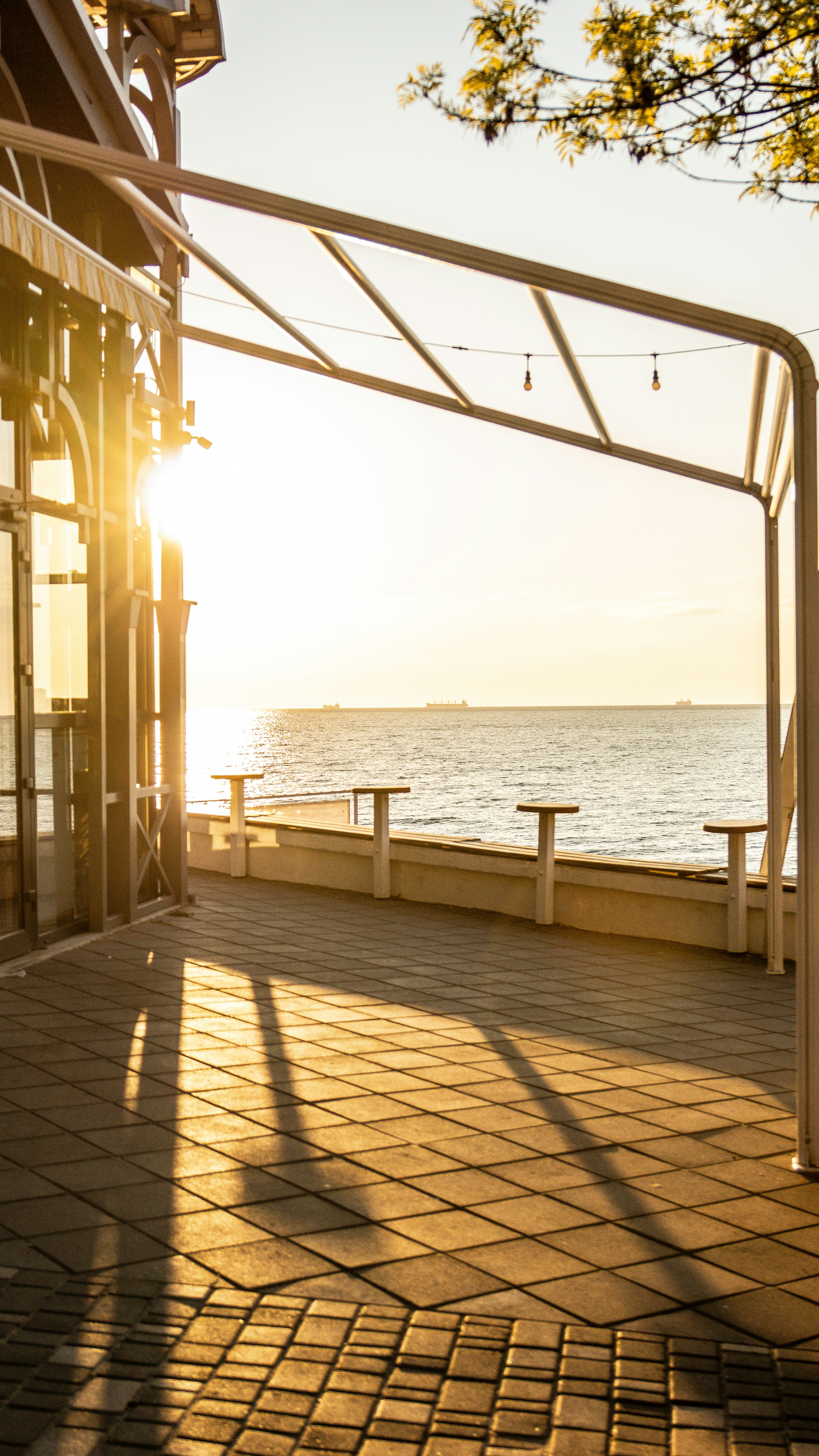 Sunlit Terrace Overlooking the Calm Sea at Dusk