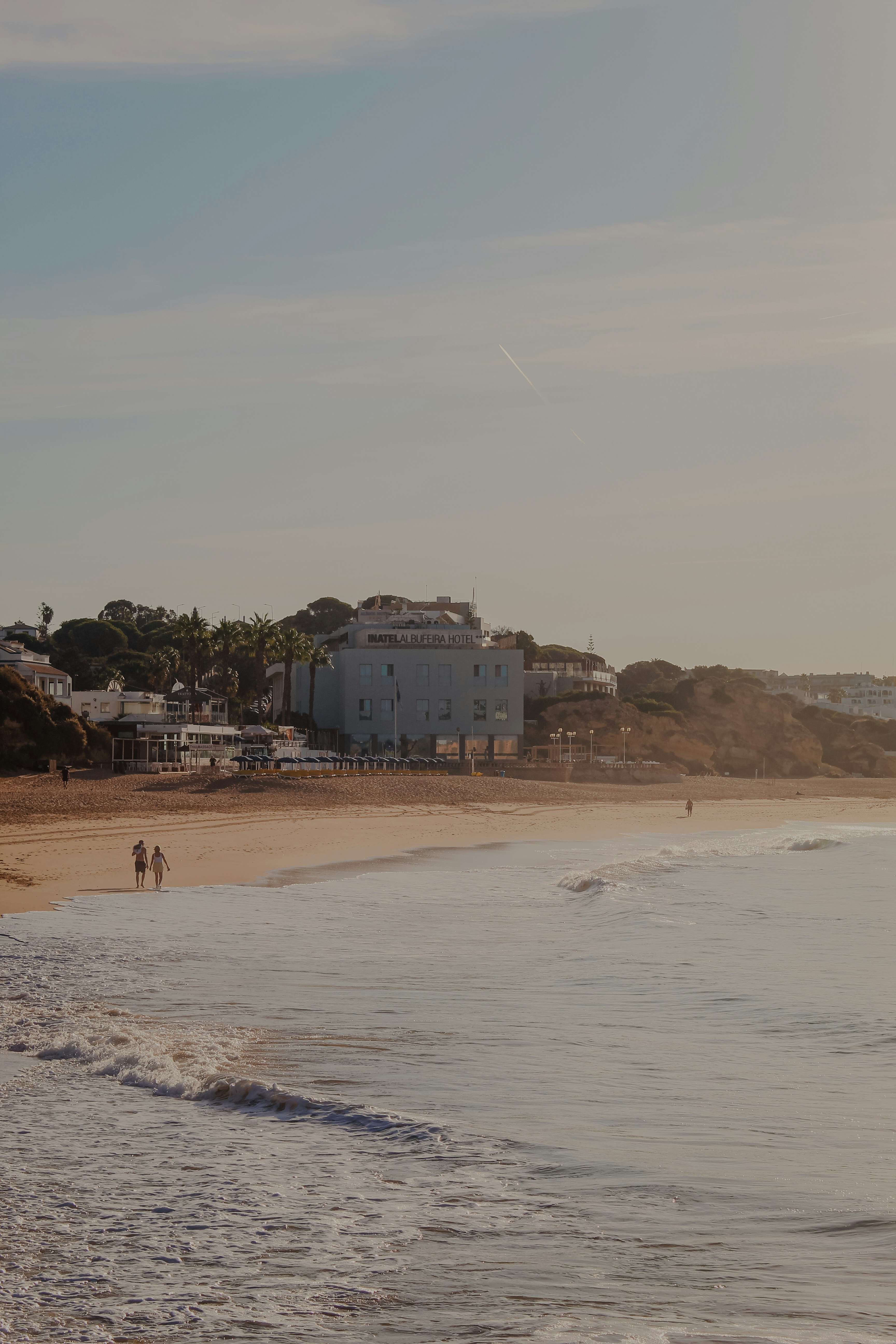 Sunlit Seascape: Quiet Beachfront Beneath a Coastal Village