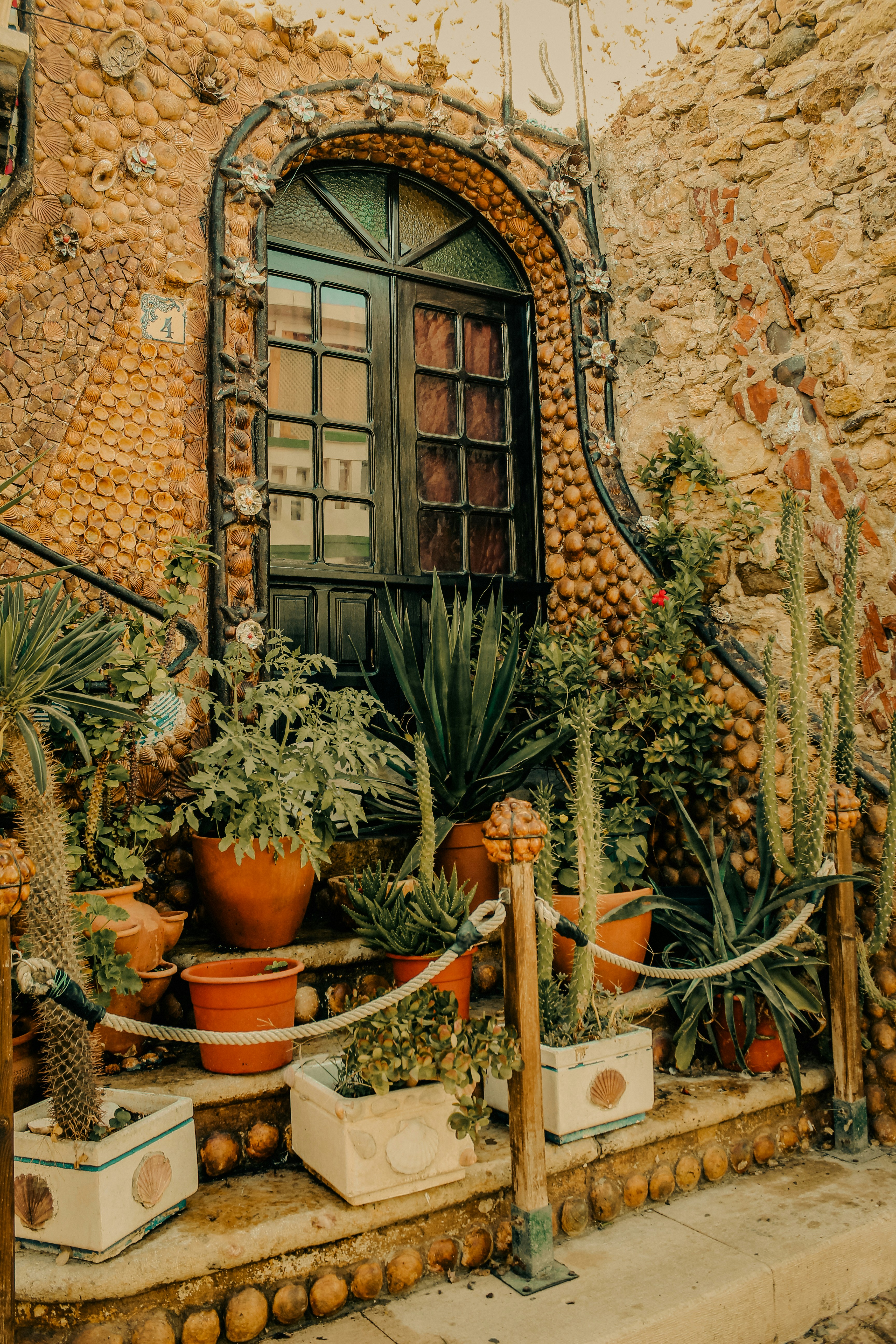 Doorway to a Sunlit Oasis: A Garden Facade Framed by Stone and Succulents