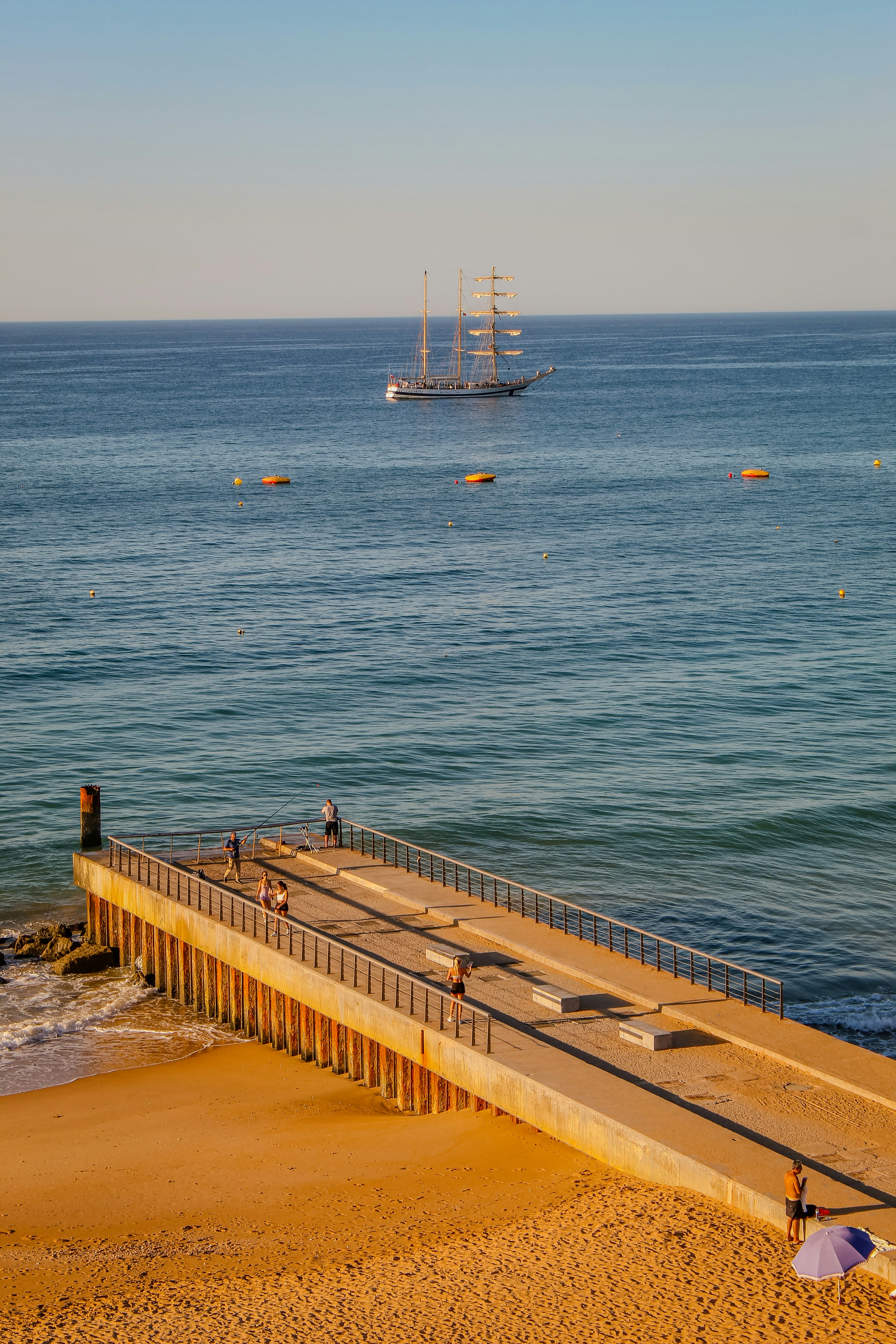 Sea Pier Extending Toward a Sailbound Horizon