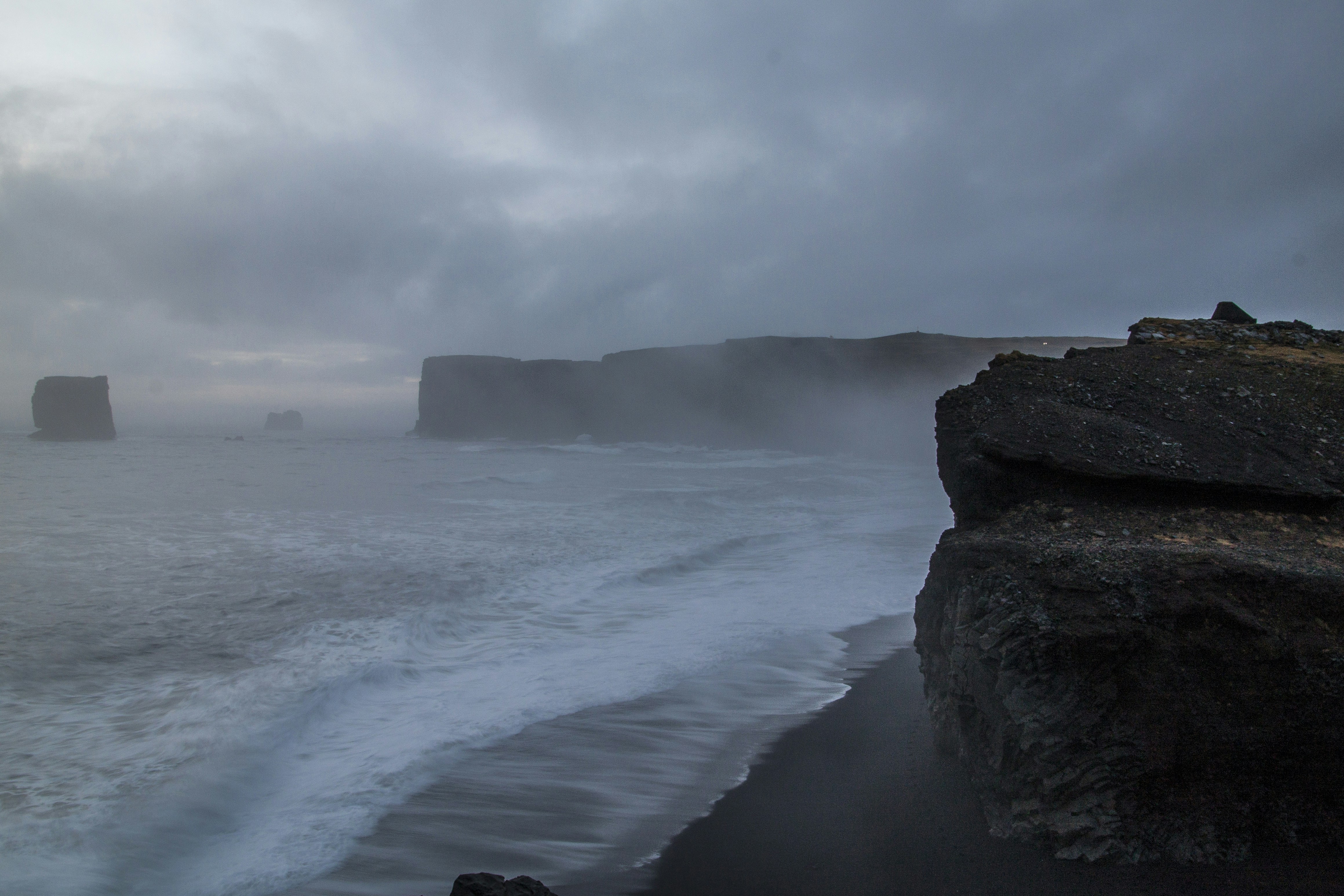 Mist over basalt cliffs: a moody coastal portrait