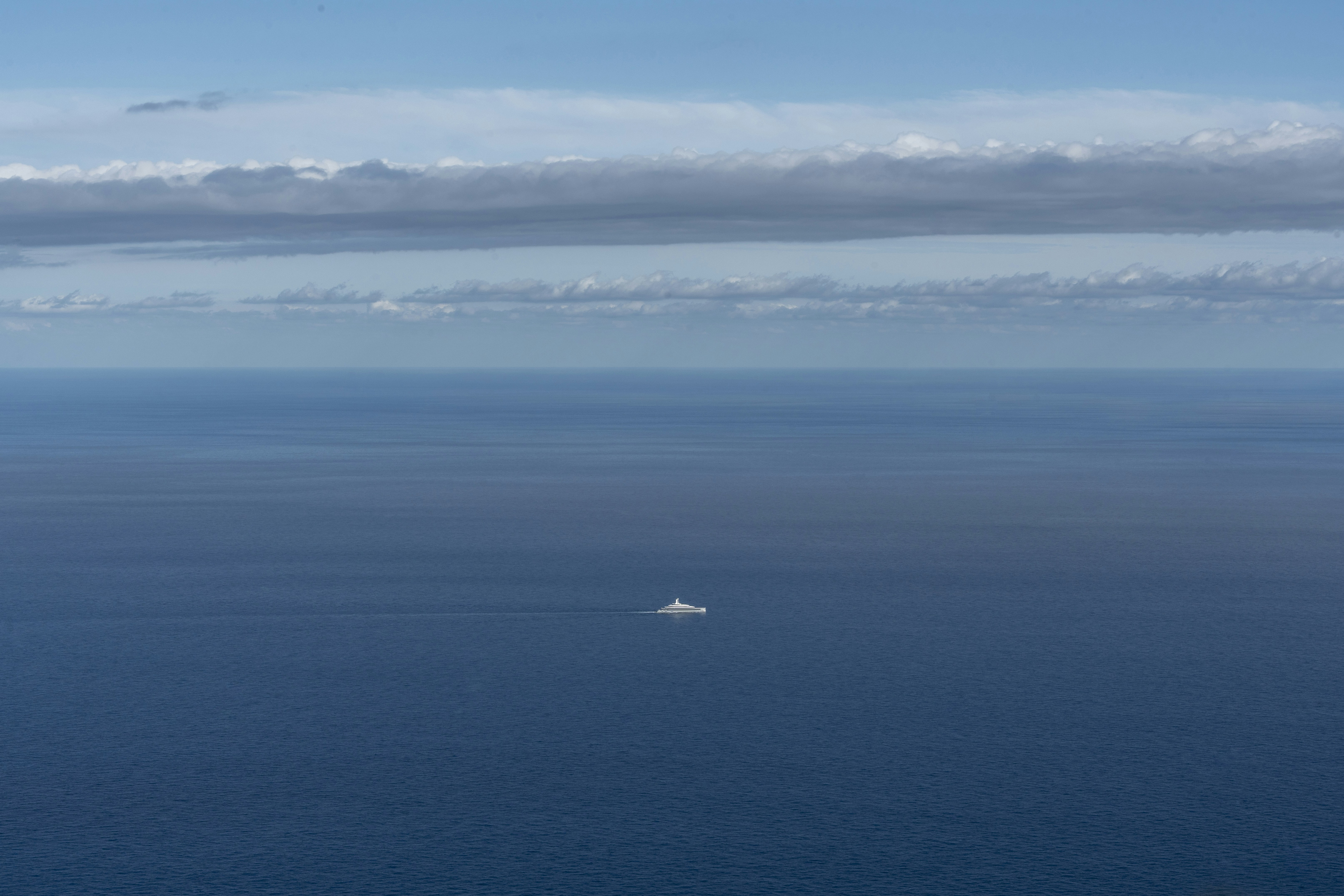 Mid-Sea Vessel: A Lone Boat Crossing the Vast Blue