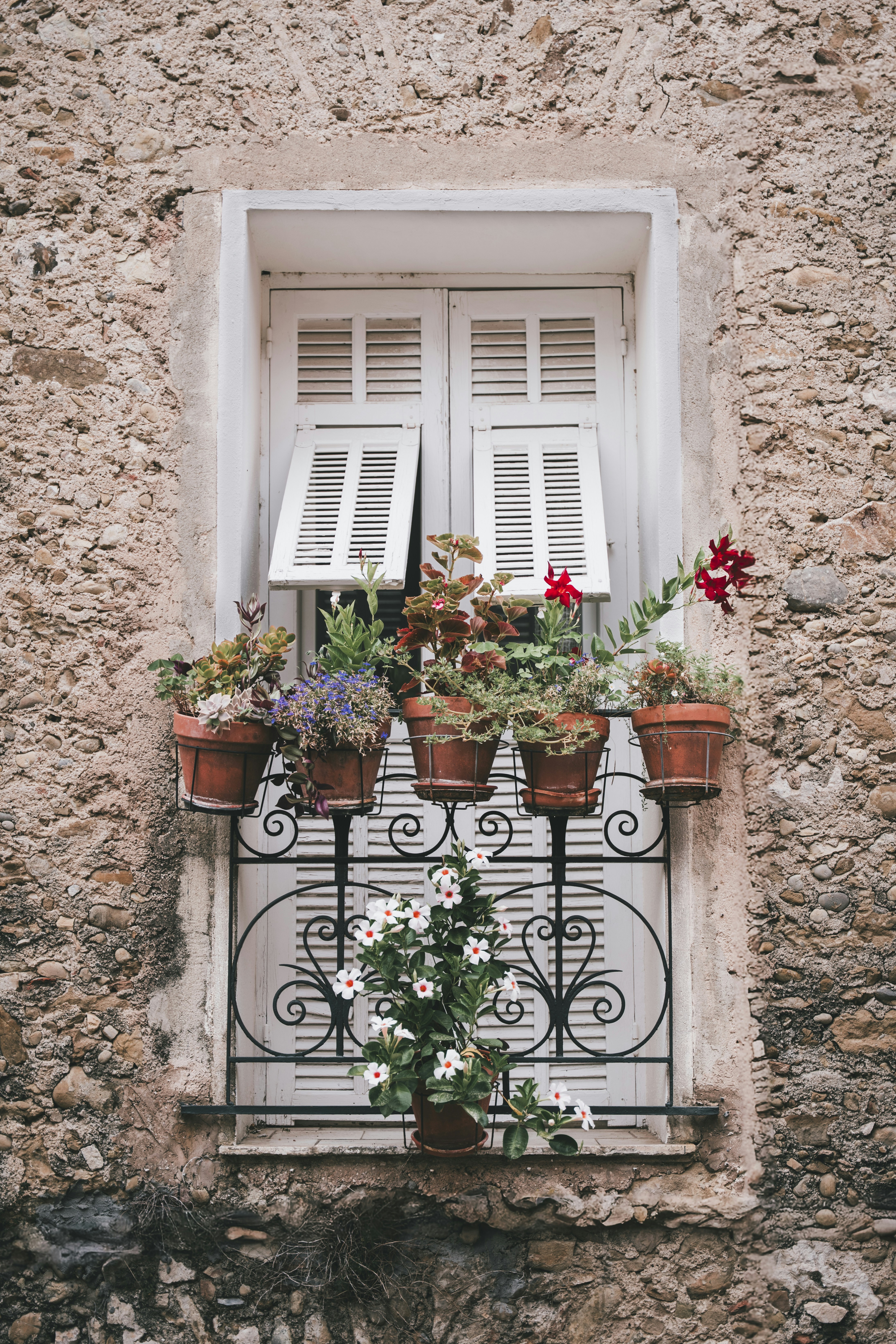 Balconied Blooms on a Weathered Facade