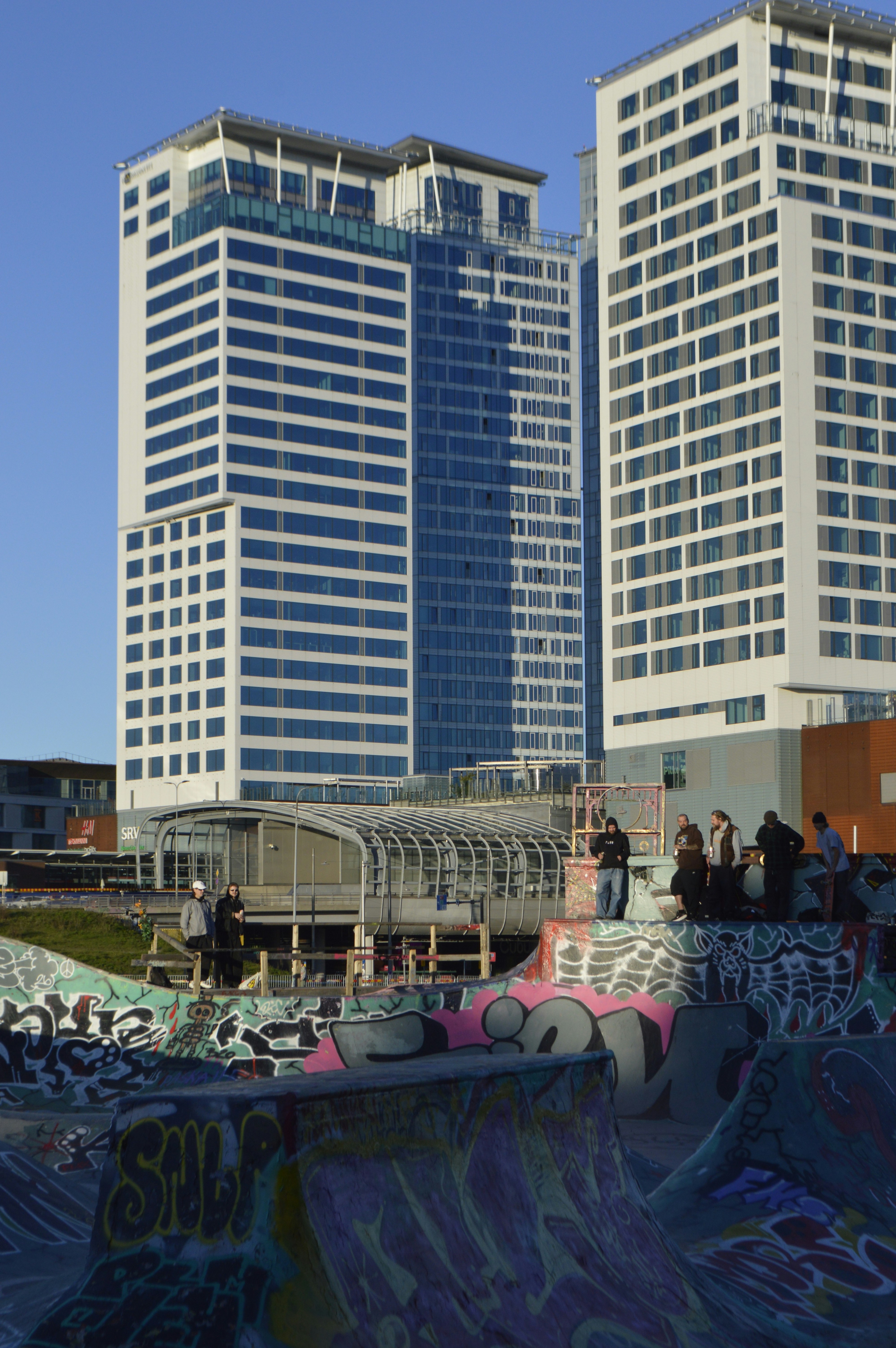 Urban Graffiti Bowl Beneath Sky-Blue Towers