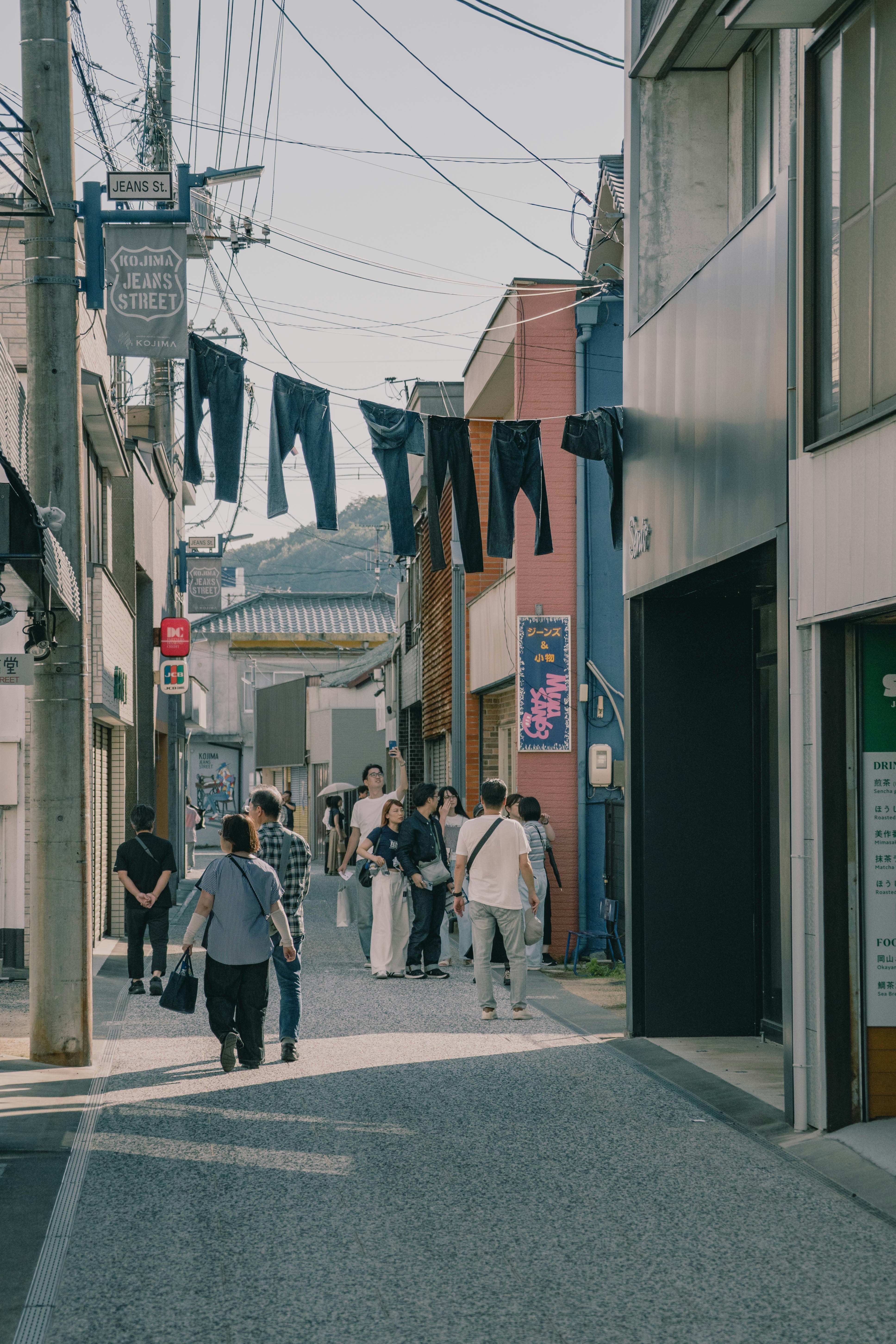 Clothesline of the Alley: A Busy Japanese Street Amid Floating Laundry