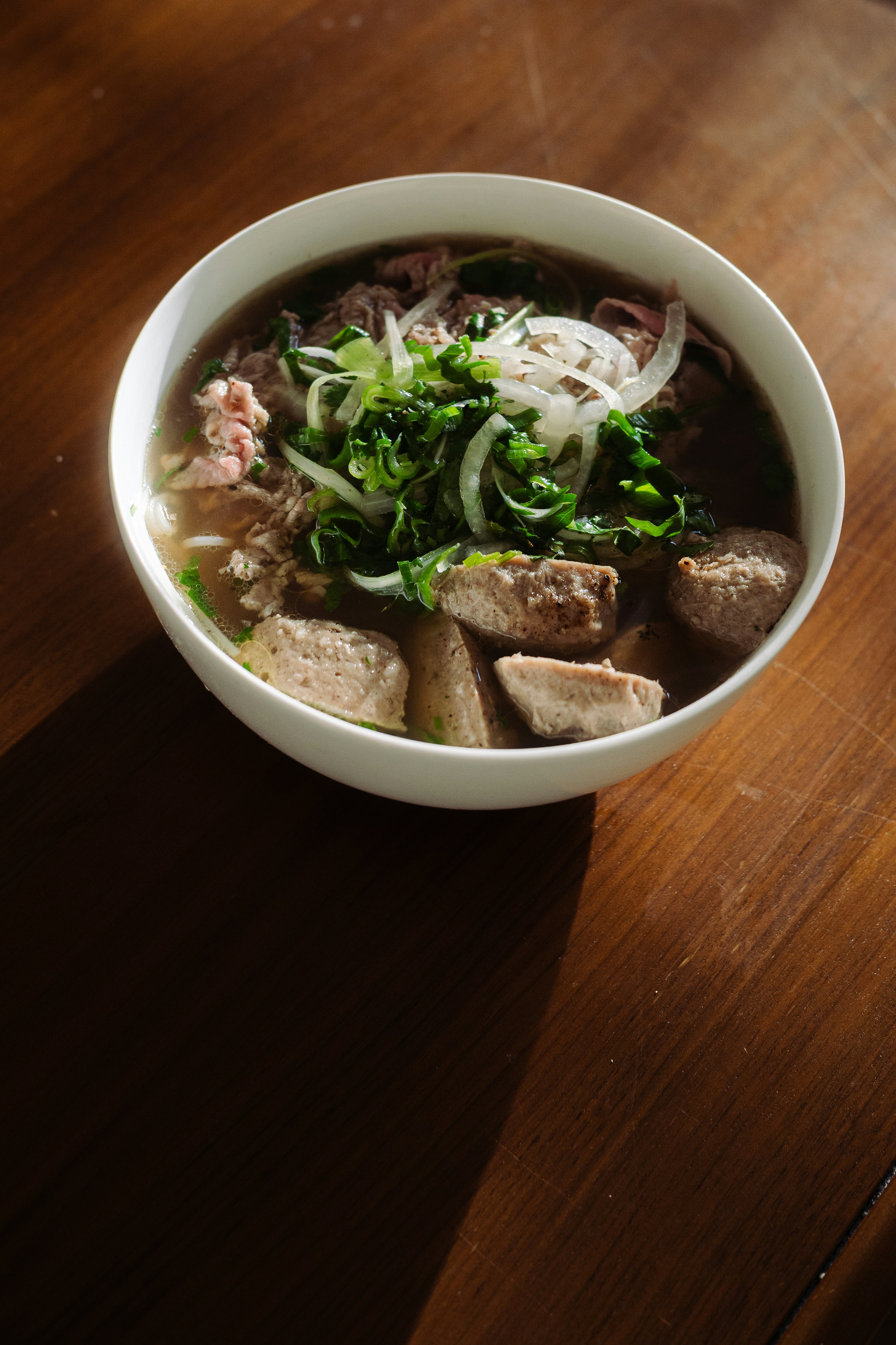 Steam-Pilled Comfort: A Bowl of Pho on a Sunlit Table