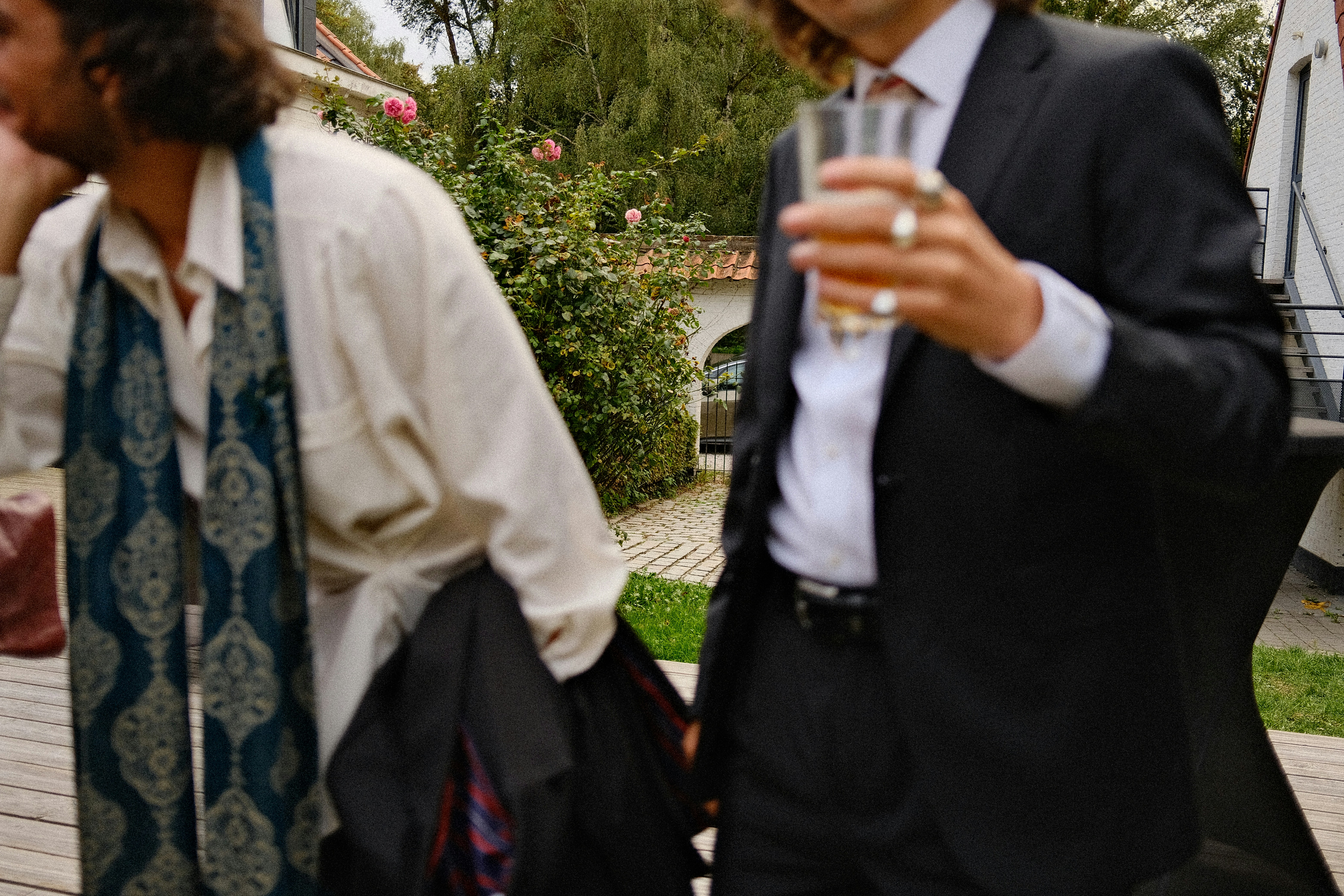 Two-Dressed Guests in Motion at a Garden Gathering