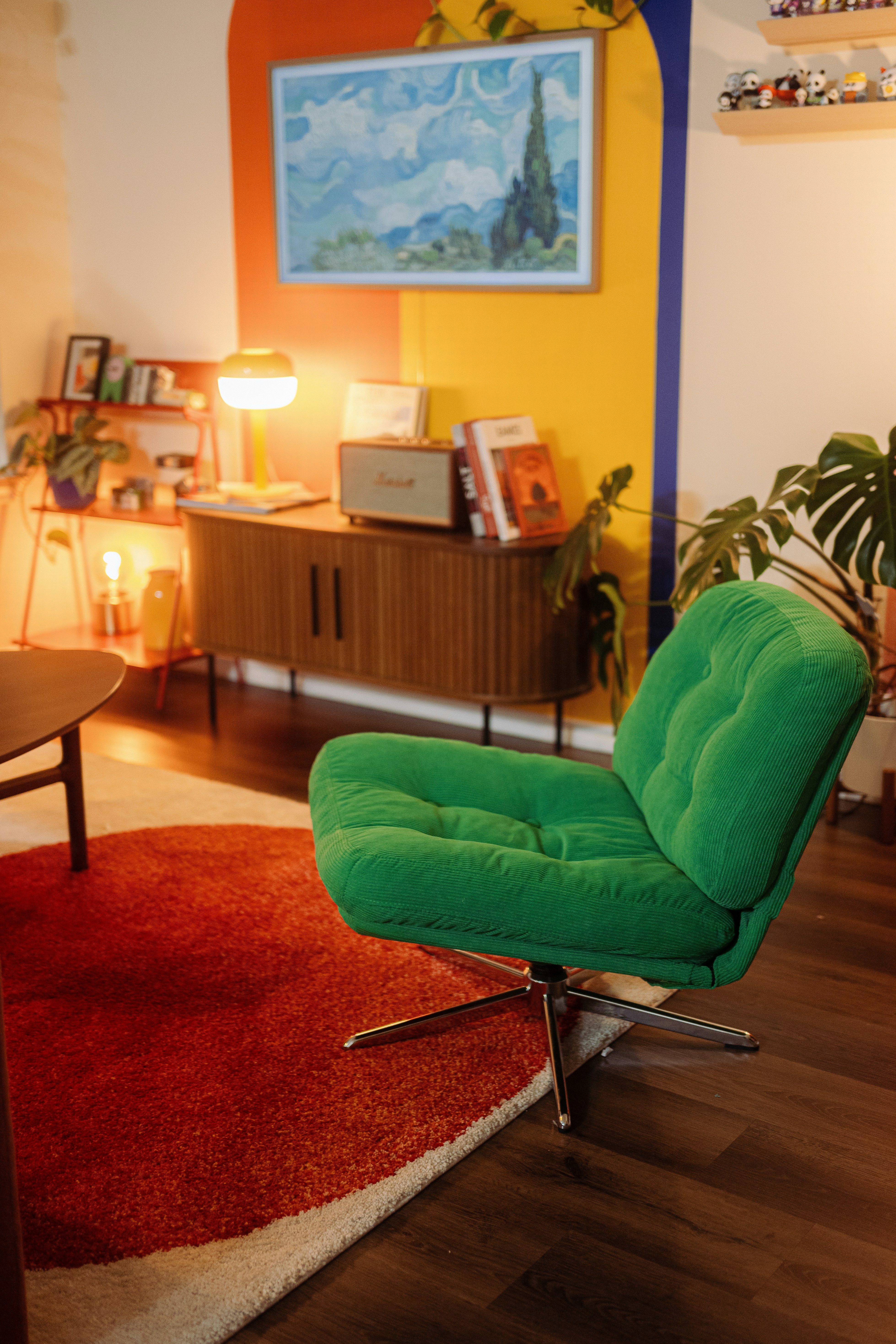 Green lounge chair anchors a warm midcentury living room