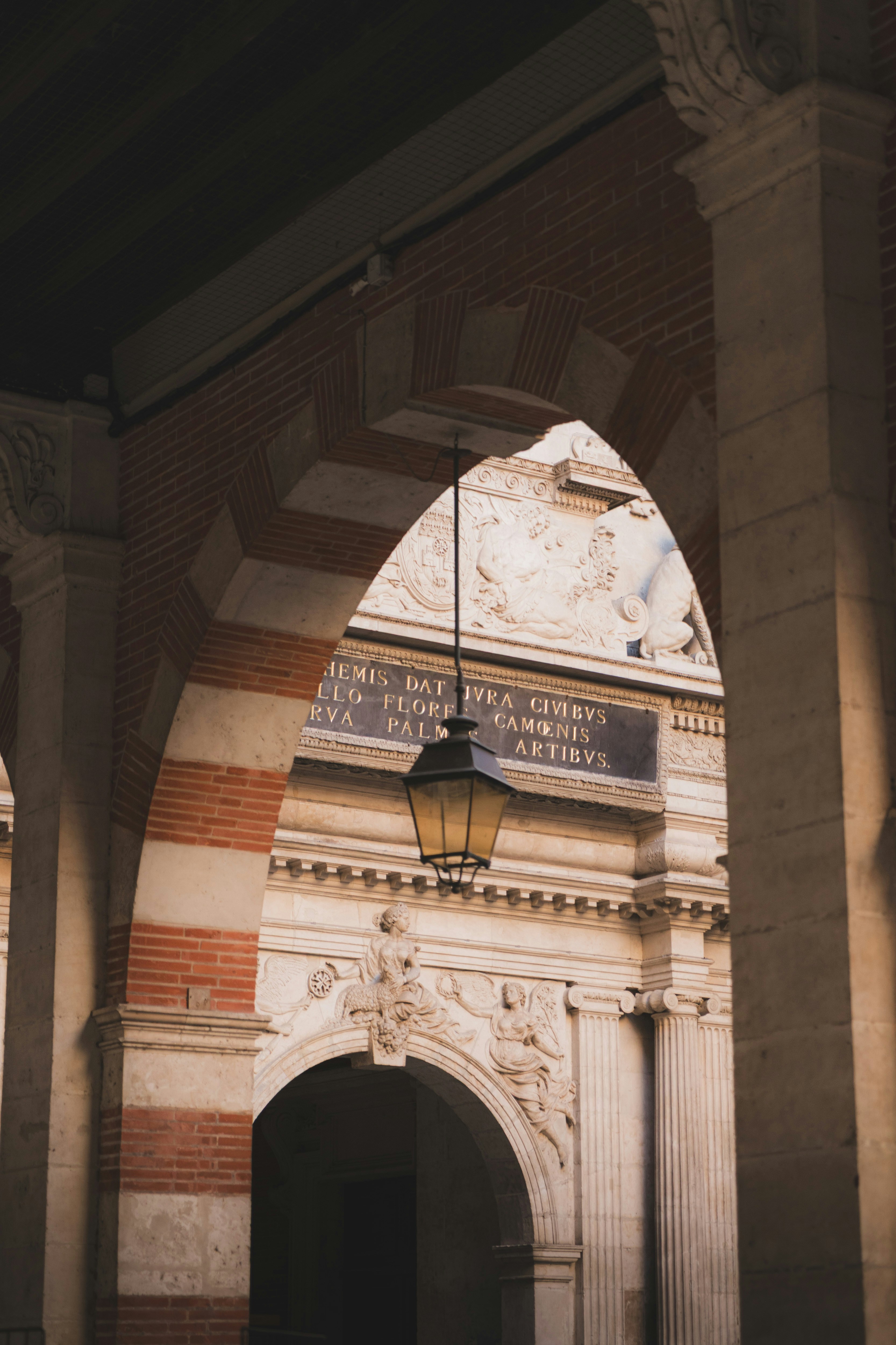 Lantern Beneath the Arched Facade