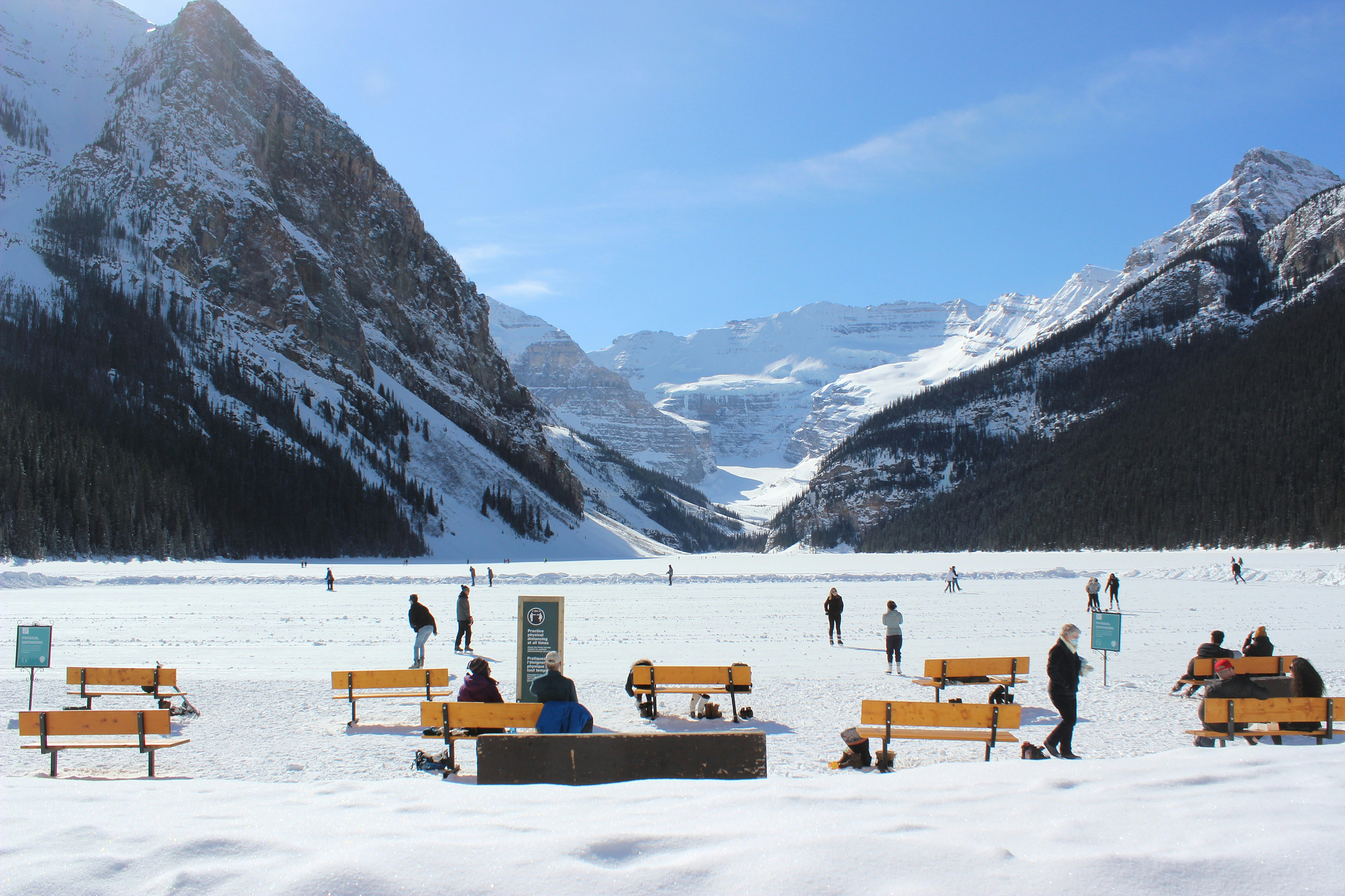 Frozen Valley Gathering: Lights, Benches, and Snow-laced Peaks