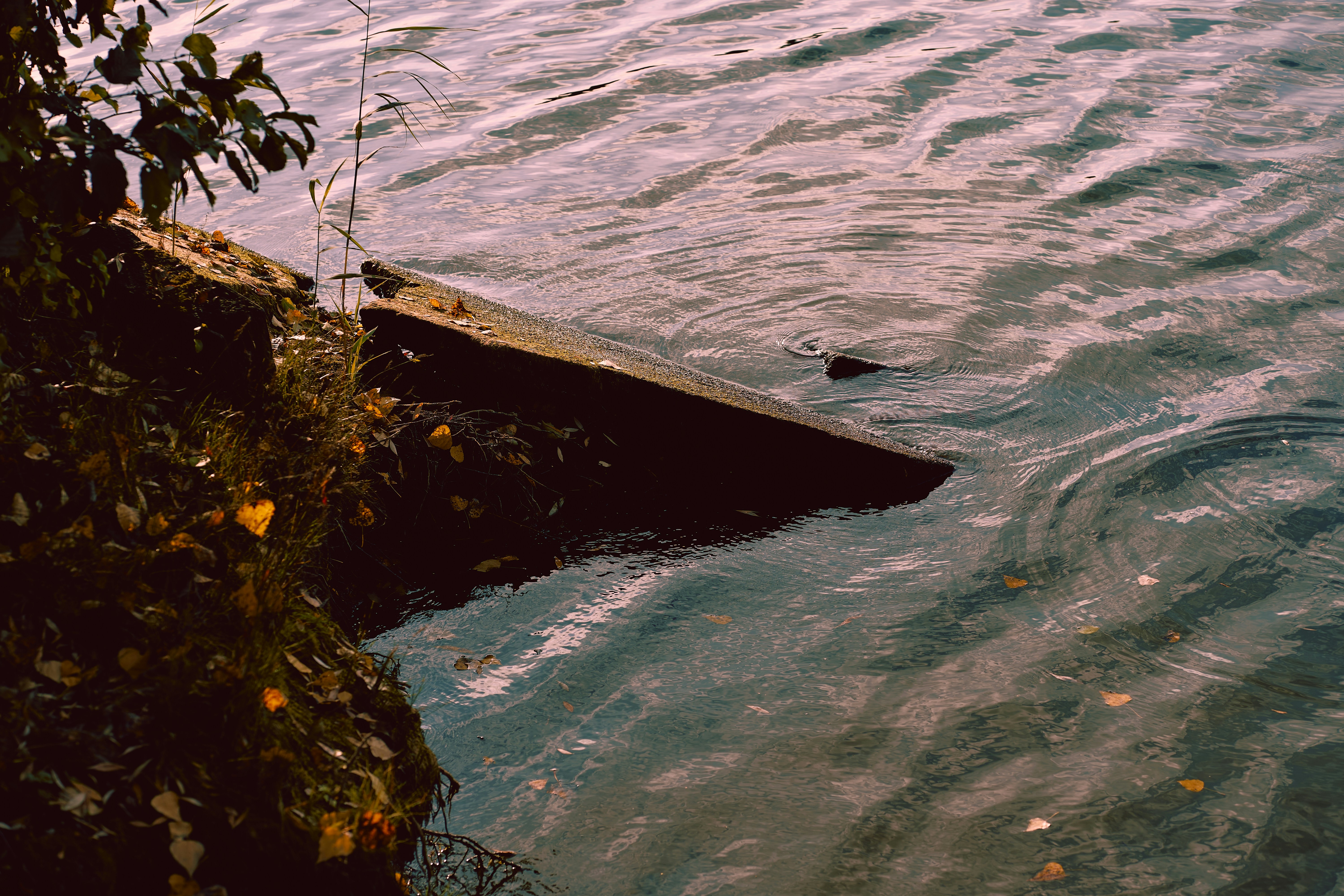 Rock ledge meeting tranquil water at the shoreline