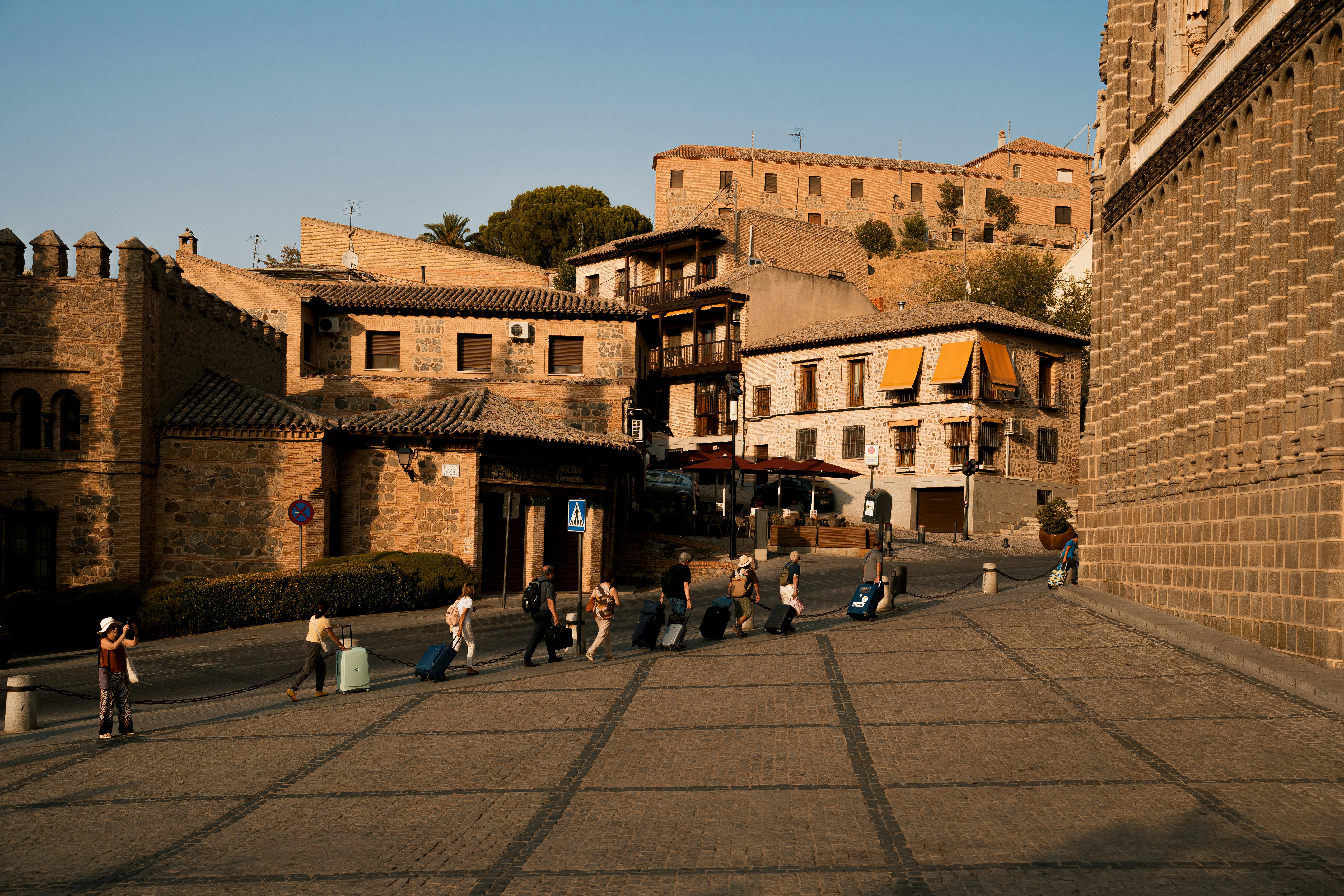 Lined up in the Old Town: Travelers in a stone-paved plaza