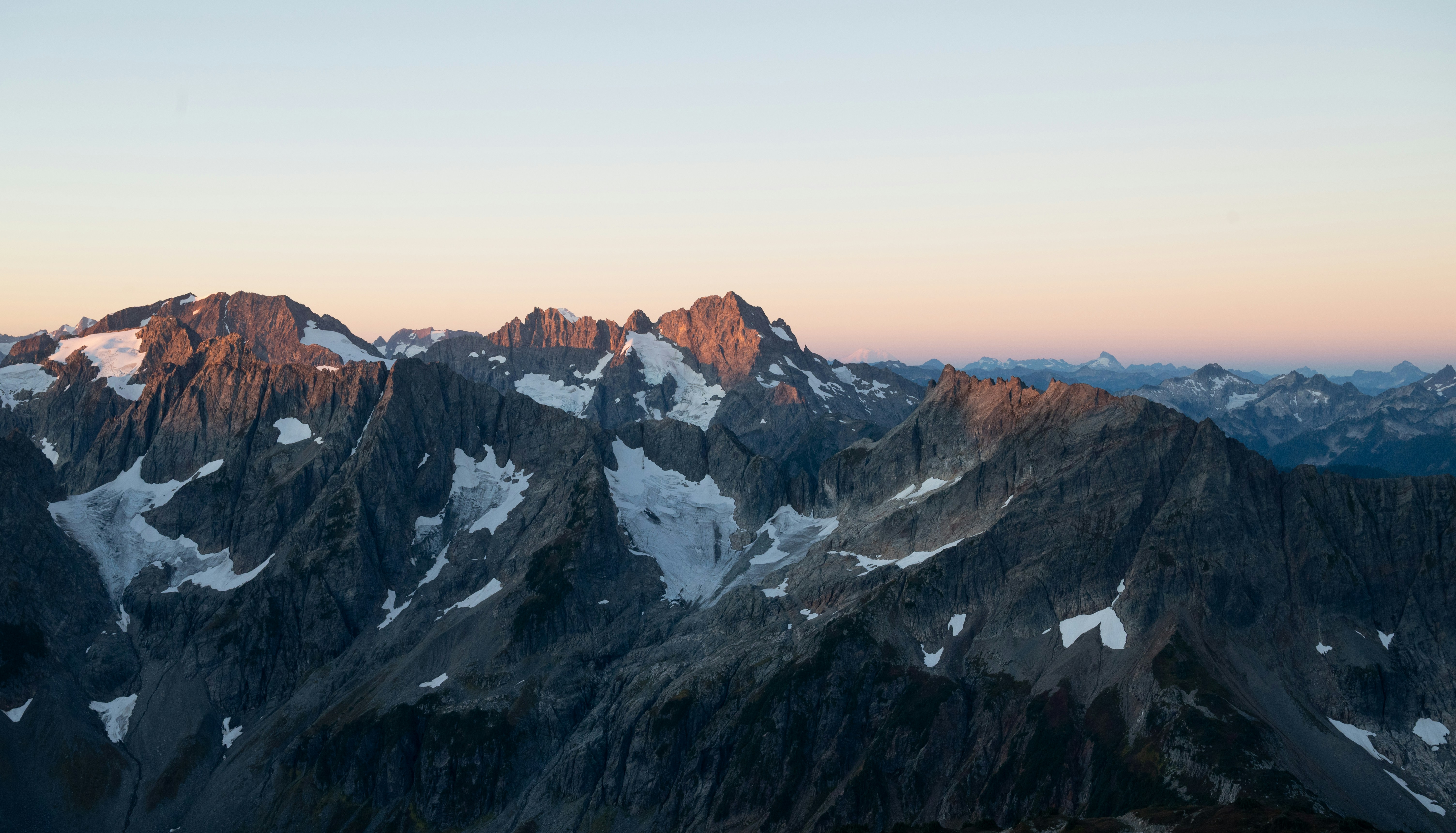 Sunrise over serrated peaks: alpine light crowns jagged ridges