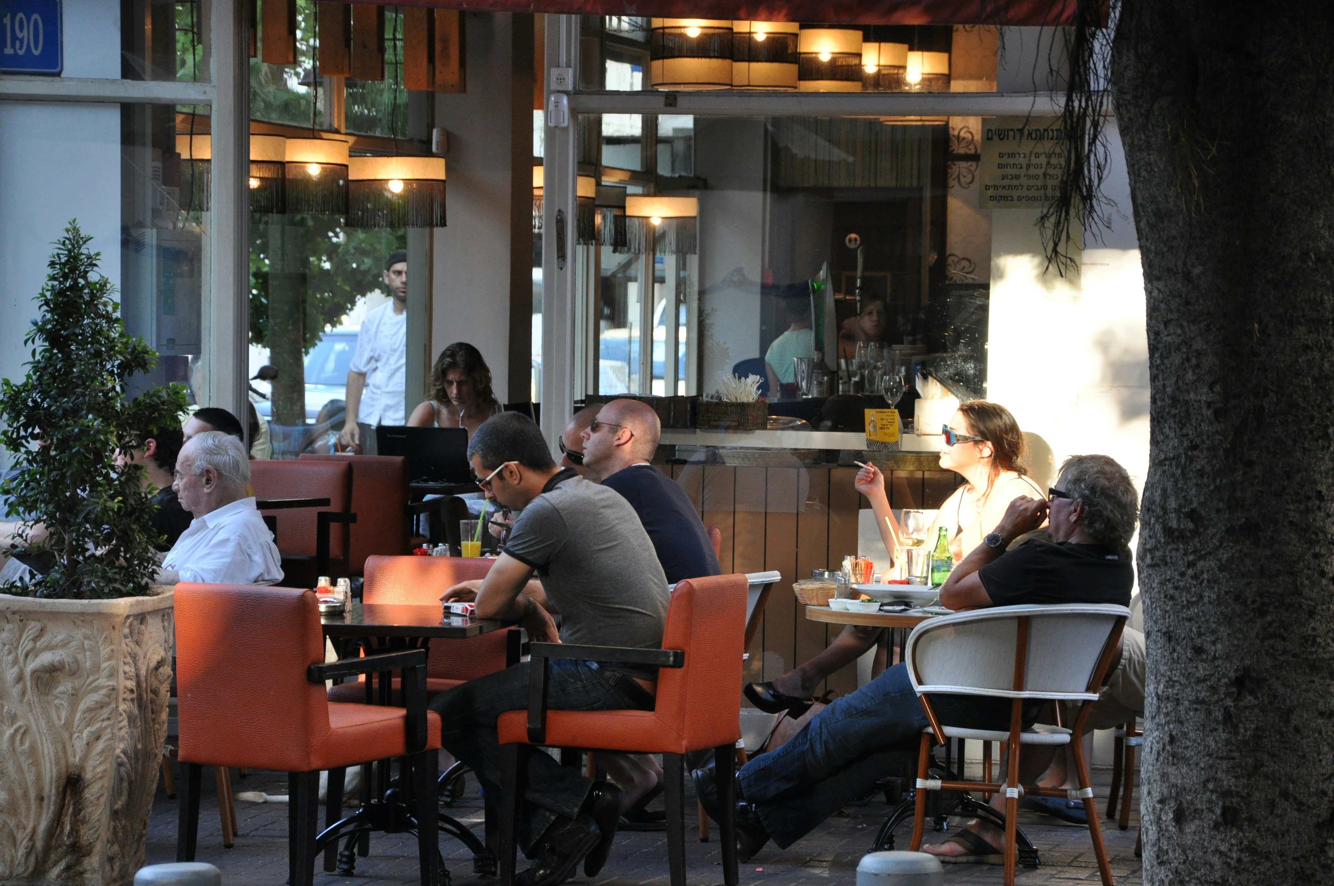 Cafe Courtyard Portrait of Shared Moments under Warm Lamps