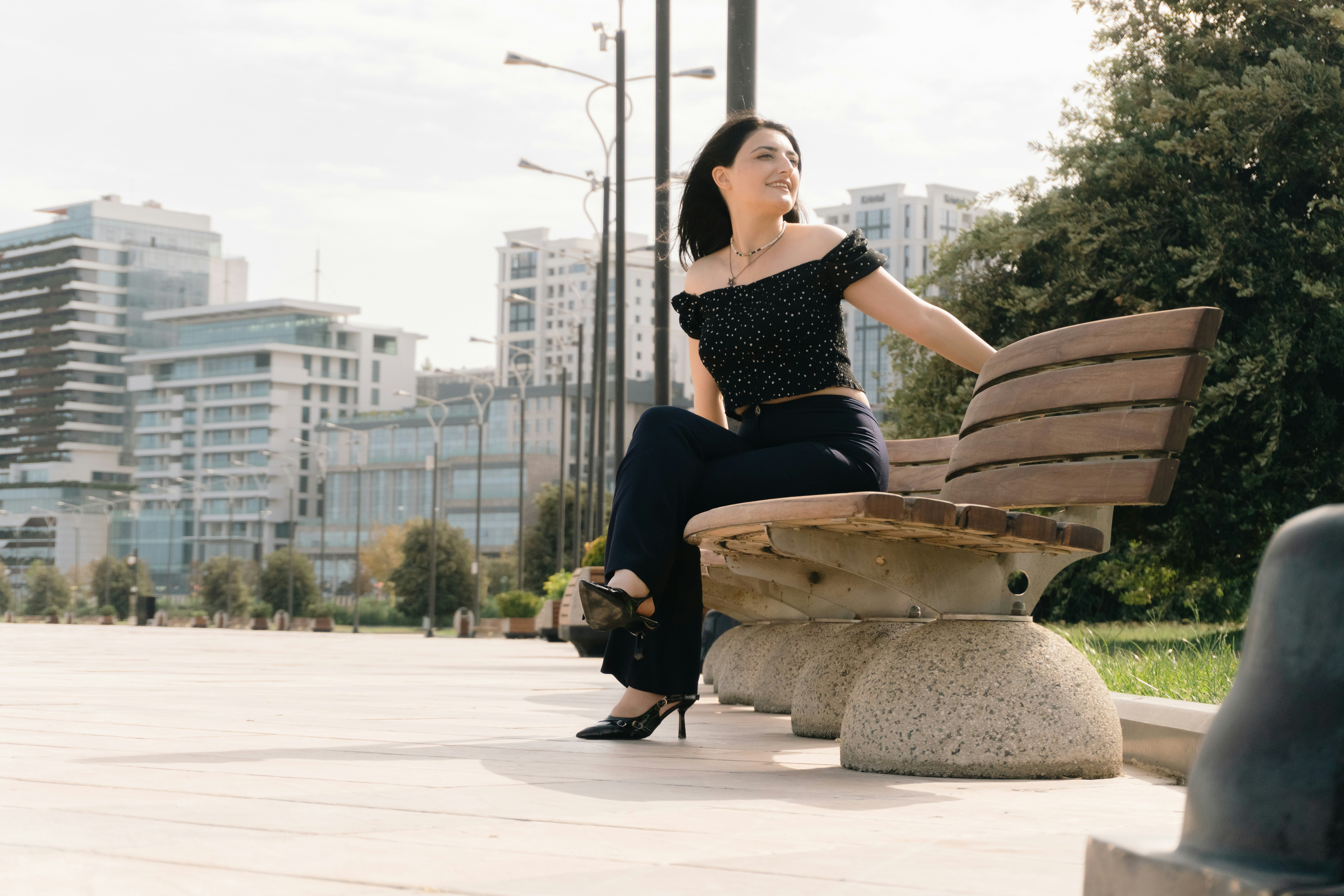 Sunlit Portrait on a Curved Concrete Bench