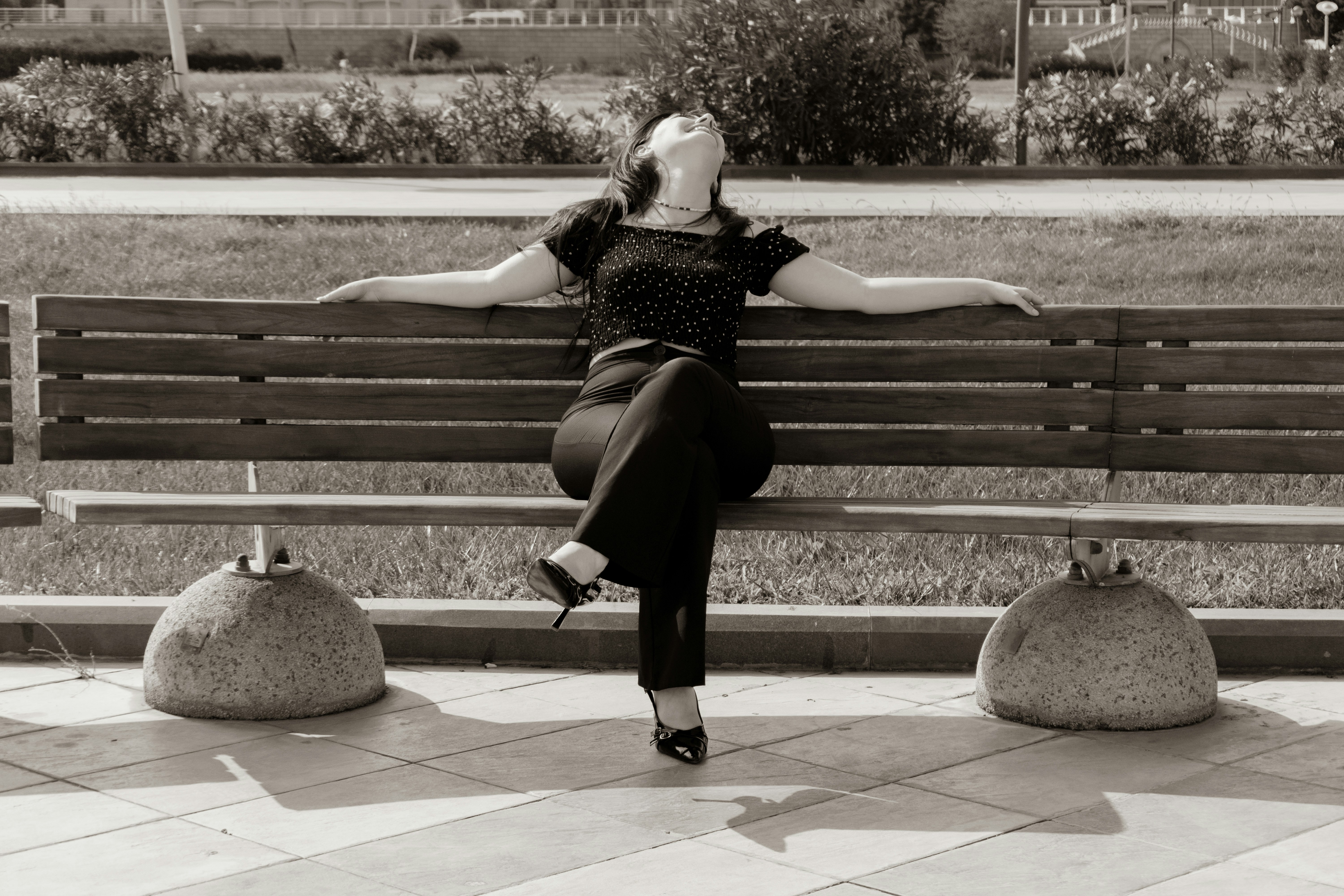 Relaxed on a Park Bench: An Afternoon of Quiet Shadows