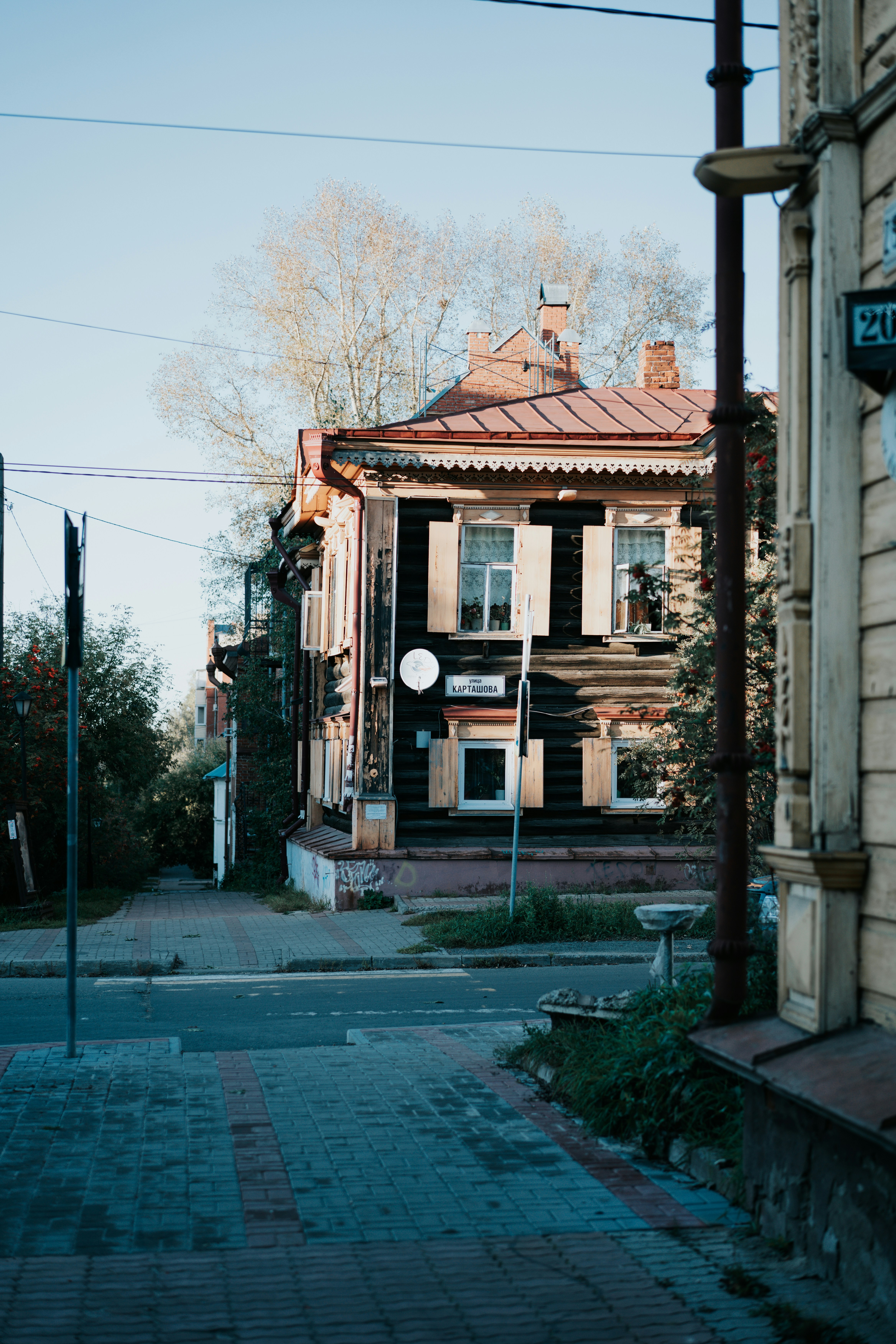 Weathered wooden house on a sunlit street corner
