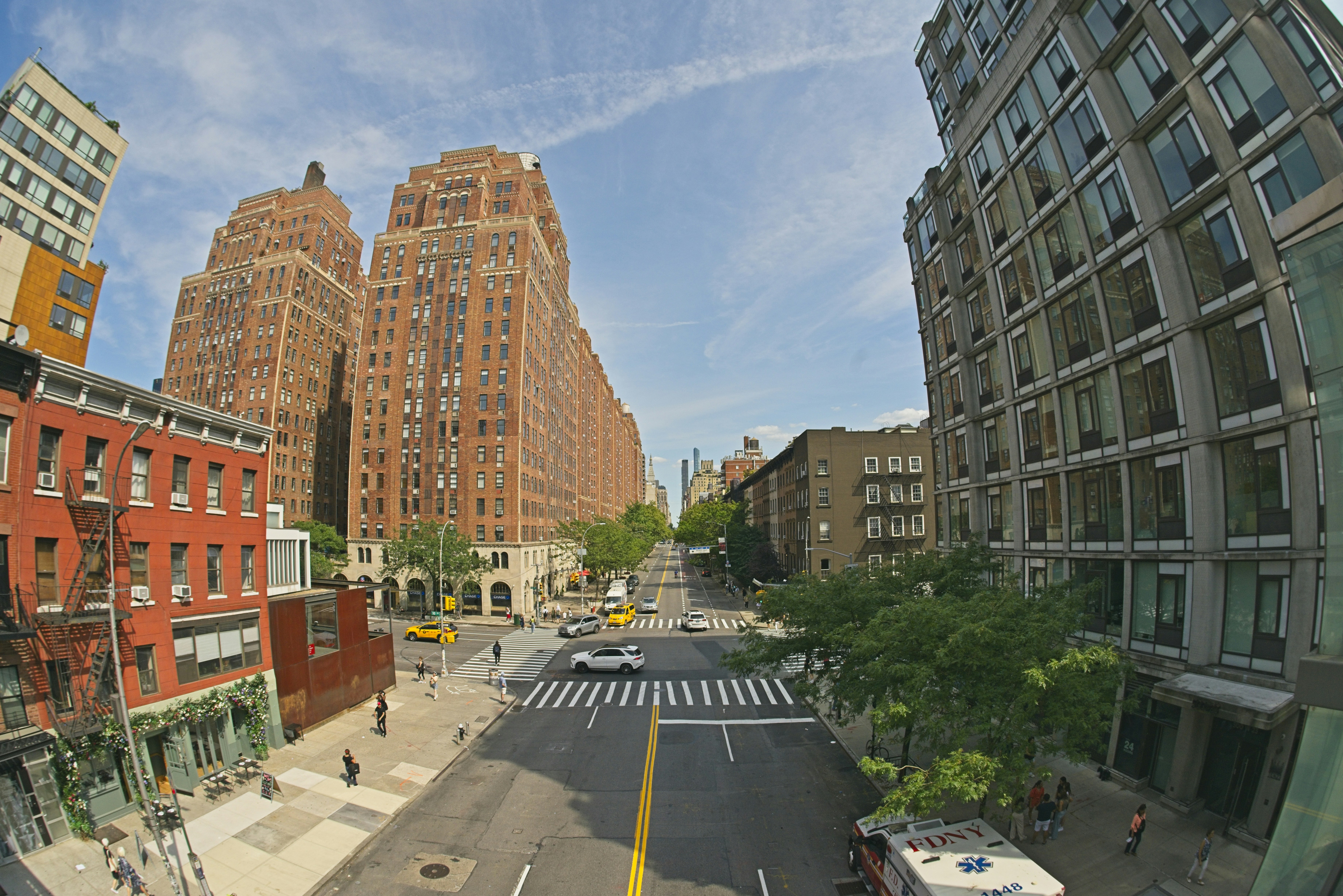 Urban Avenue Converges: A Sunlit Street Between Brick and Glass