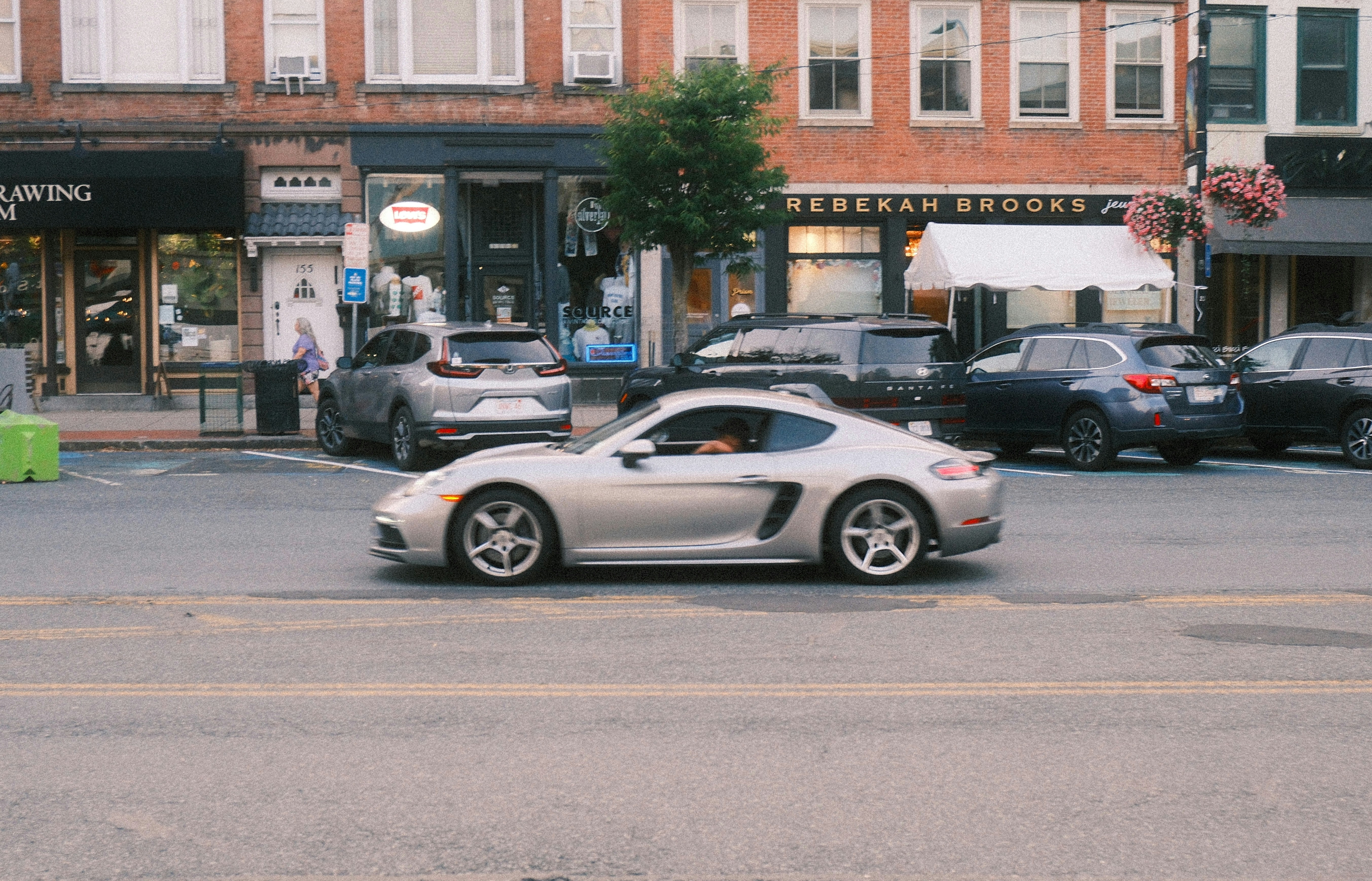 Silver Carrera in Motion: A City Street Snapshot