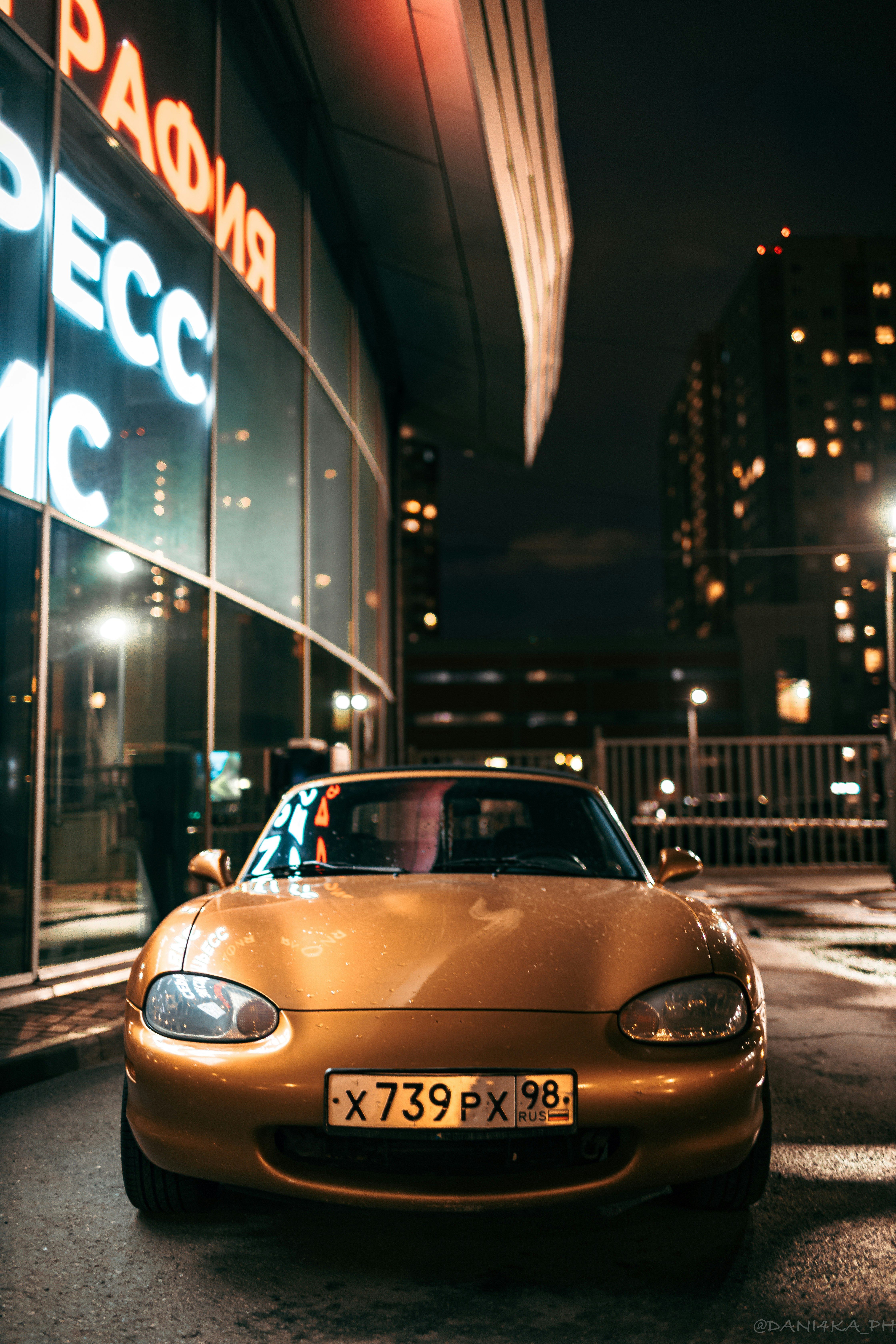 Golden Coupe Under Neon Night: City Reflections