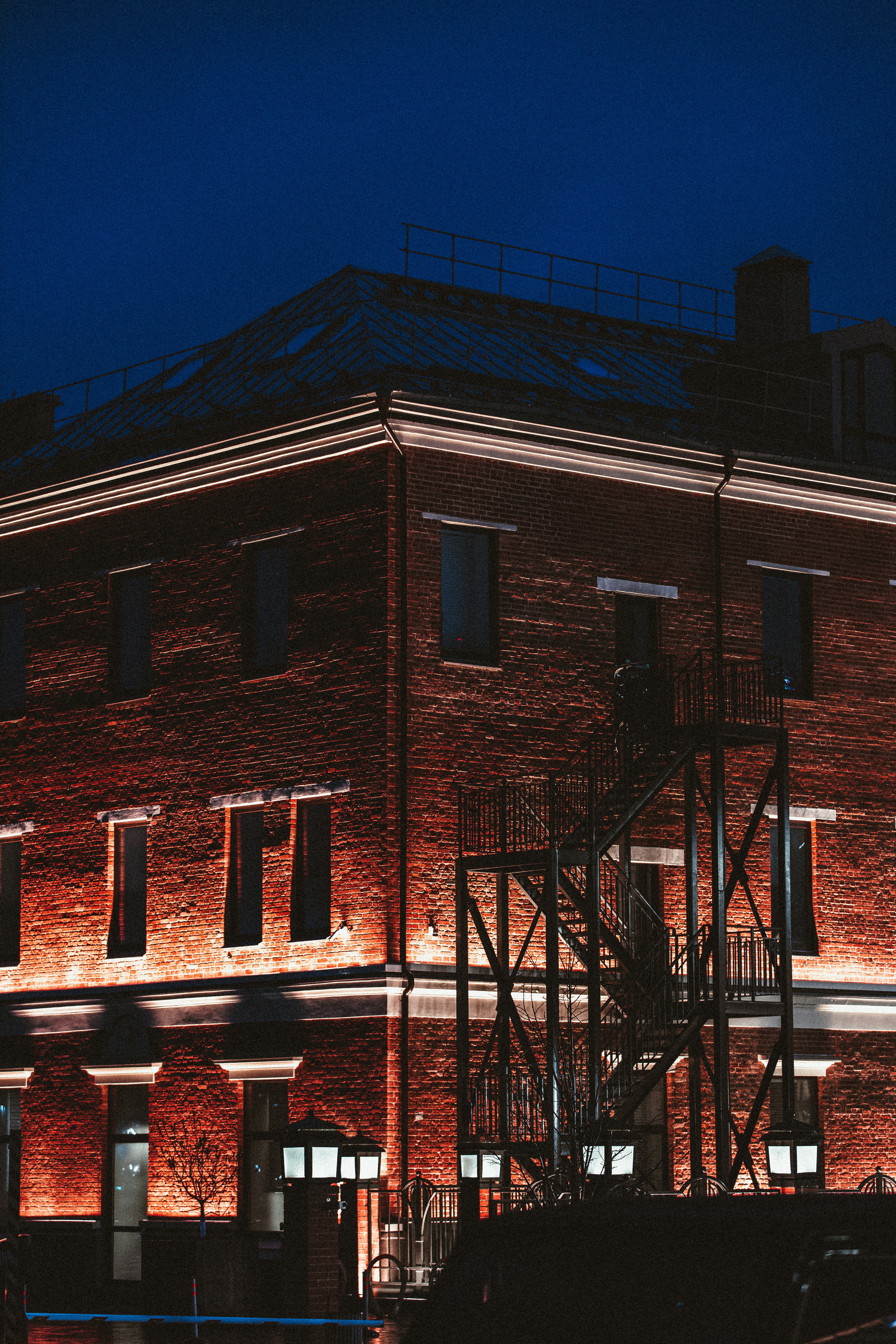Night Brick: Firelit Facade of an Industrial Building