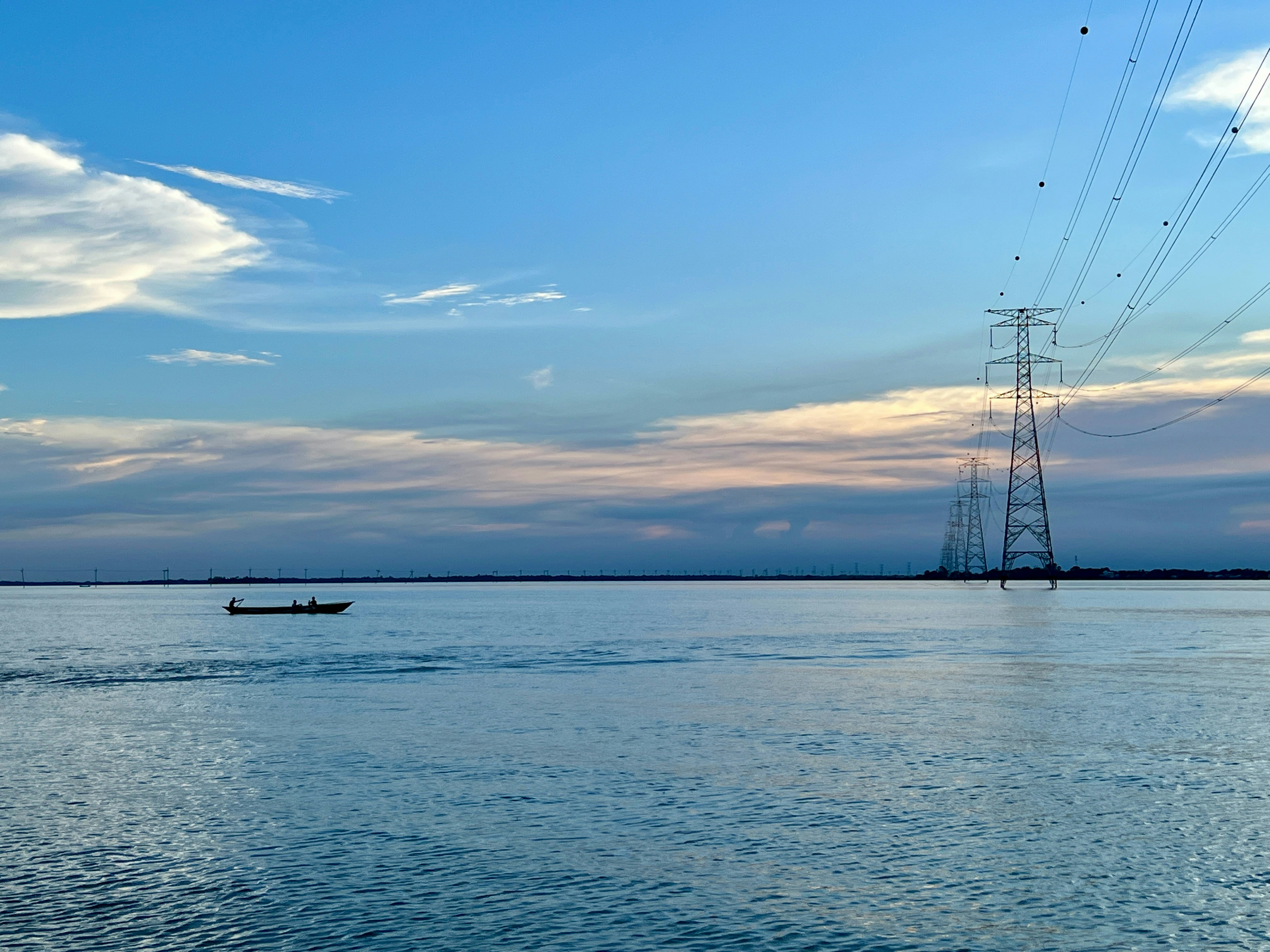 Low Tide, High Wires: A Quiet River Stretch Under a Silent Sky