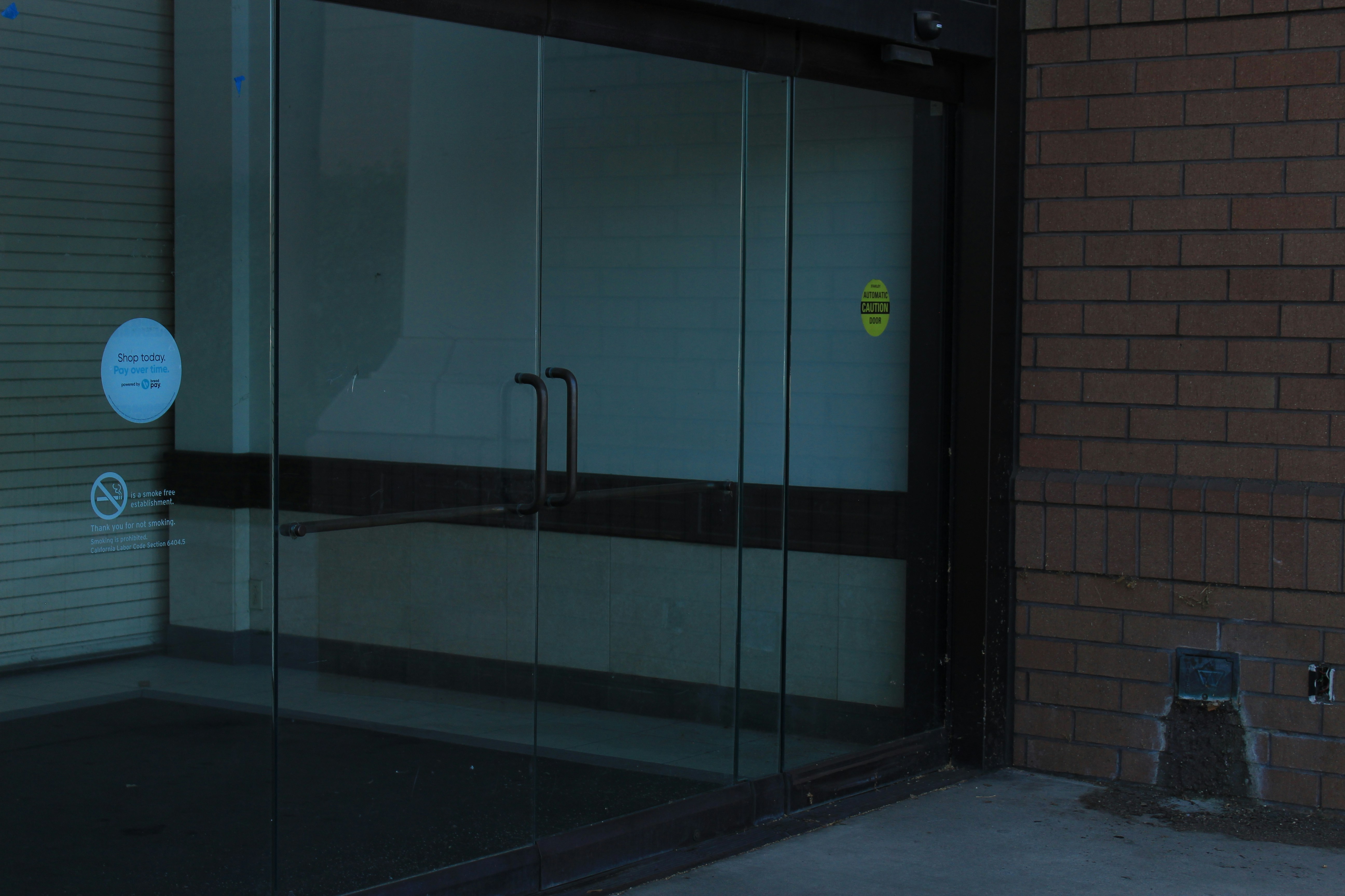 Quiet Glass Threshold: Reflections and Doors at Dusk