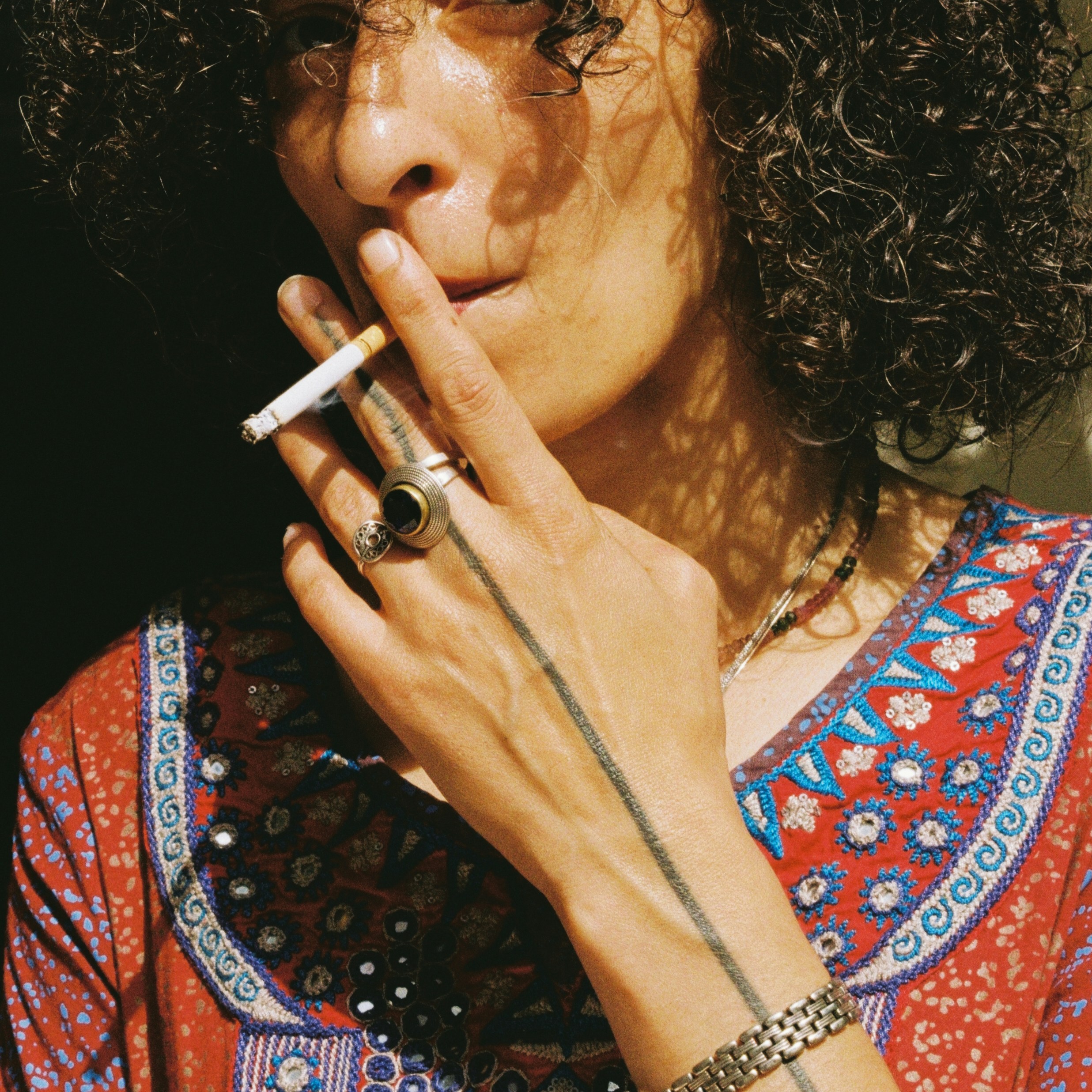 Smoke and Shadow: A Quiet Portrait in Sunlit Strands