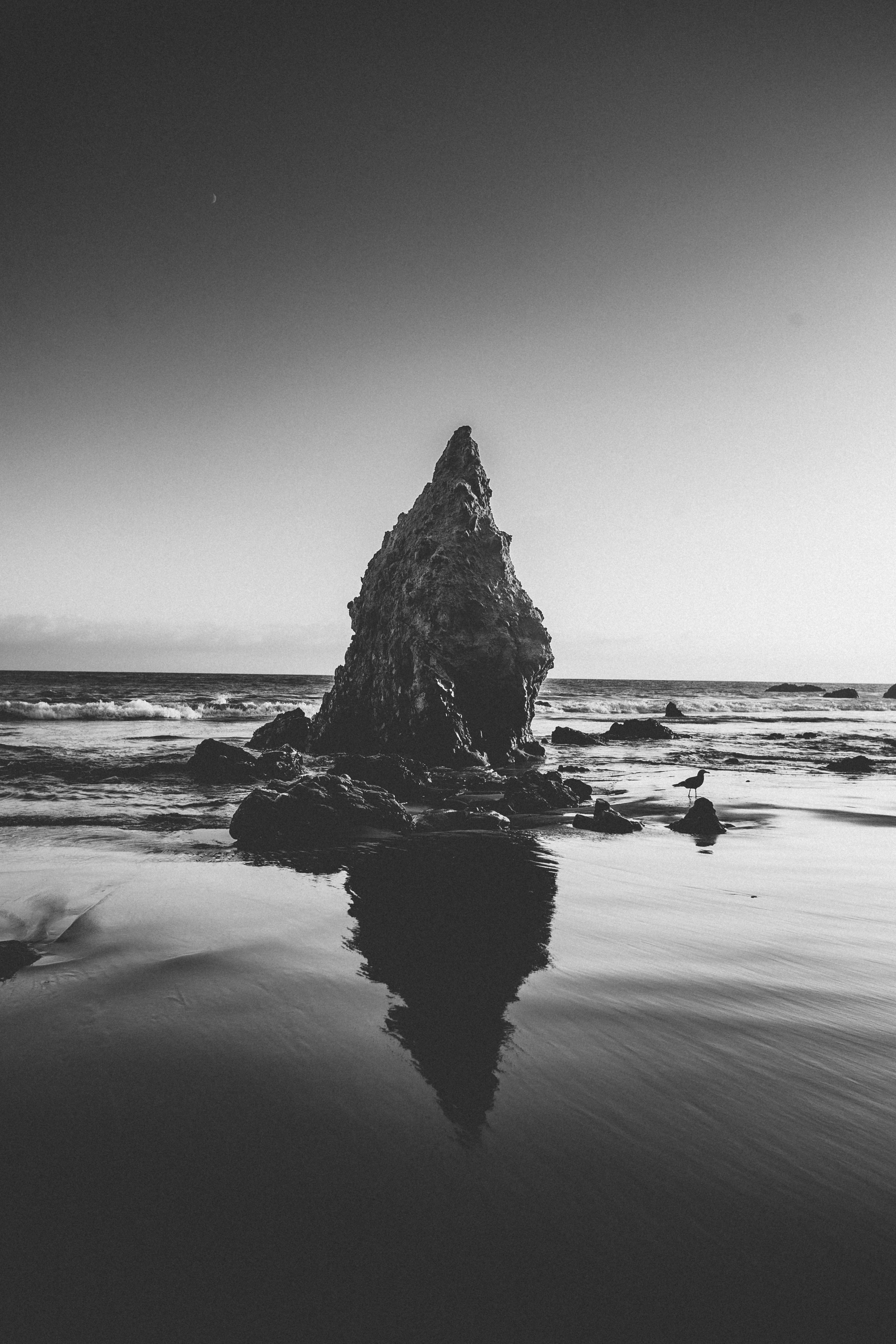 Mirror of Stone: A Lone Sea Rock Reaches Toward the Horizon