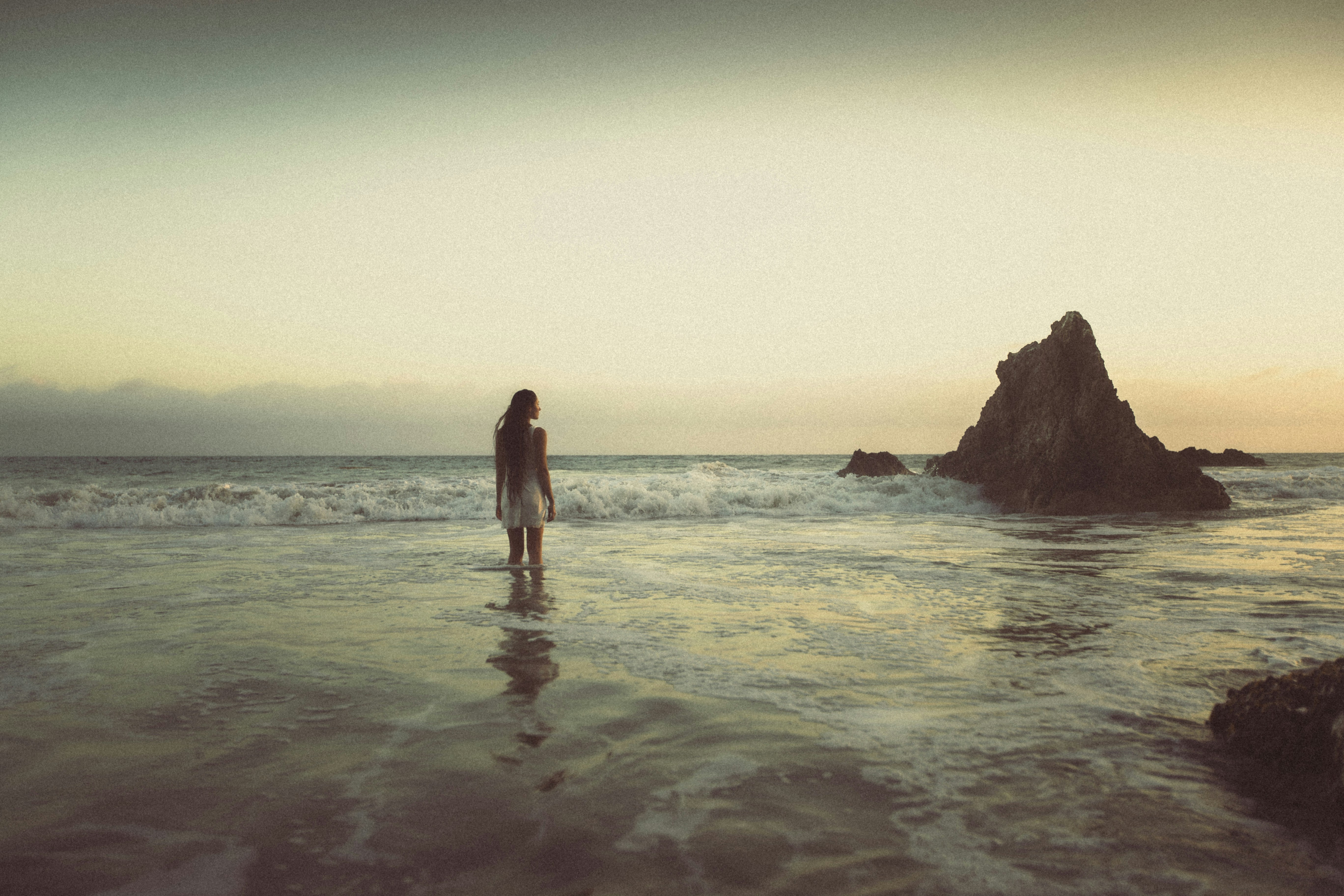 Solitary Figure at Dusk: A Quiet Shoreline
