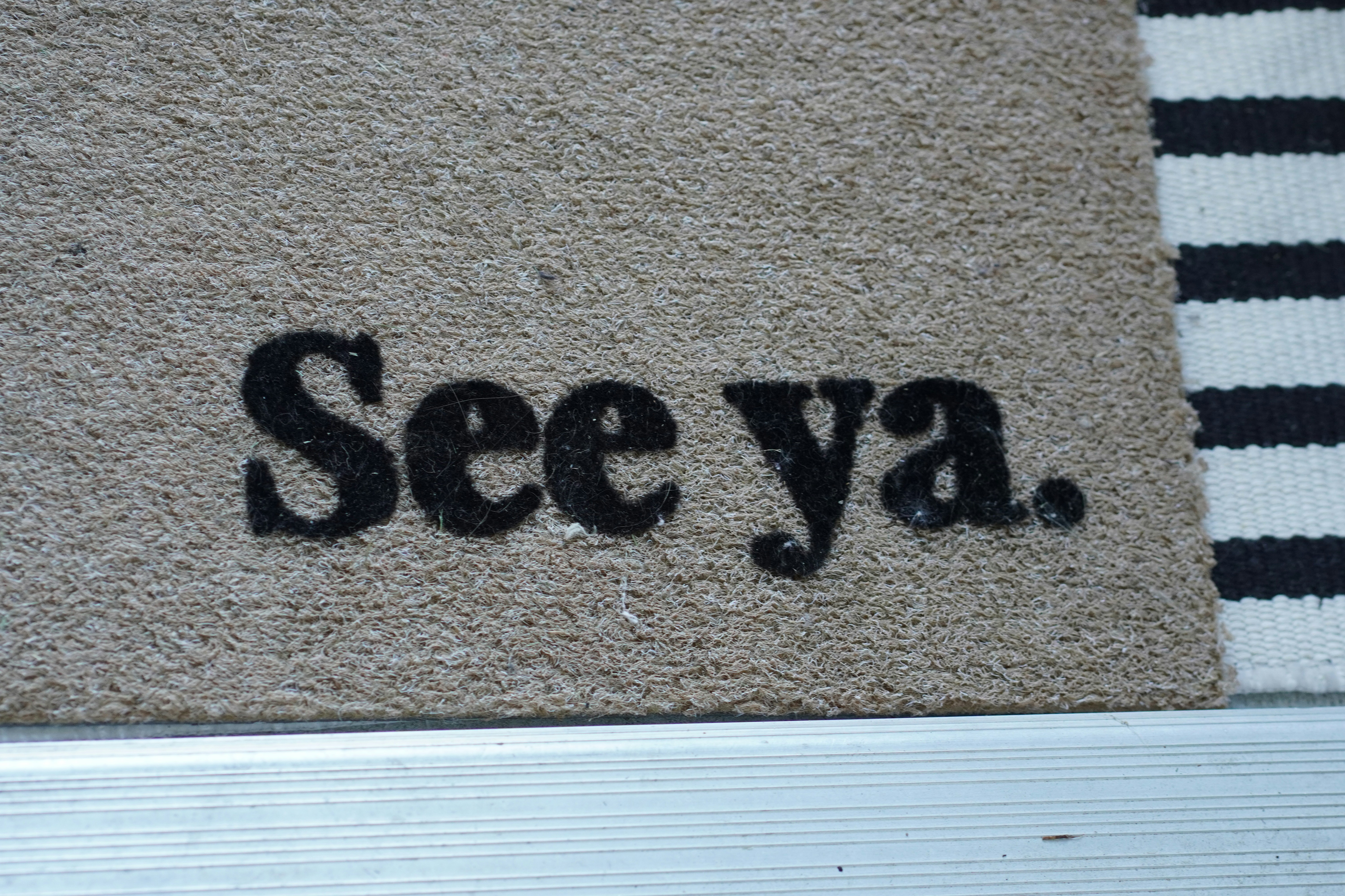 See ya at the threshold: a close-up of the doormat with bold typography