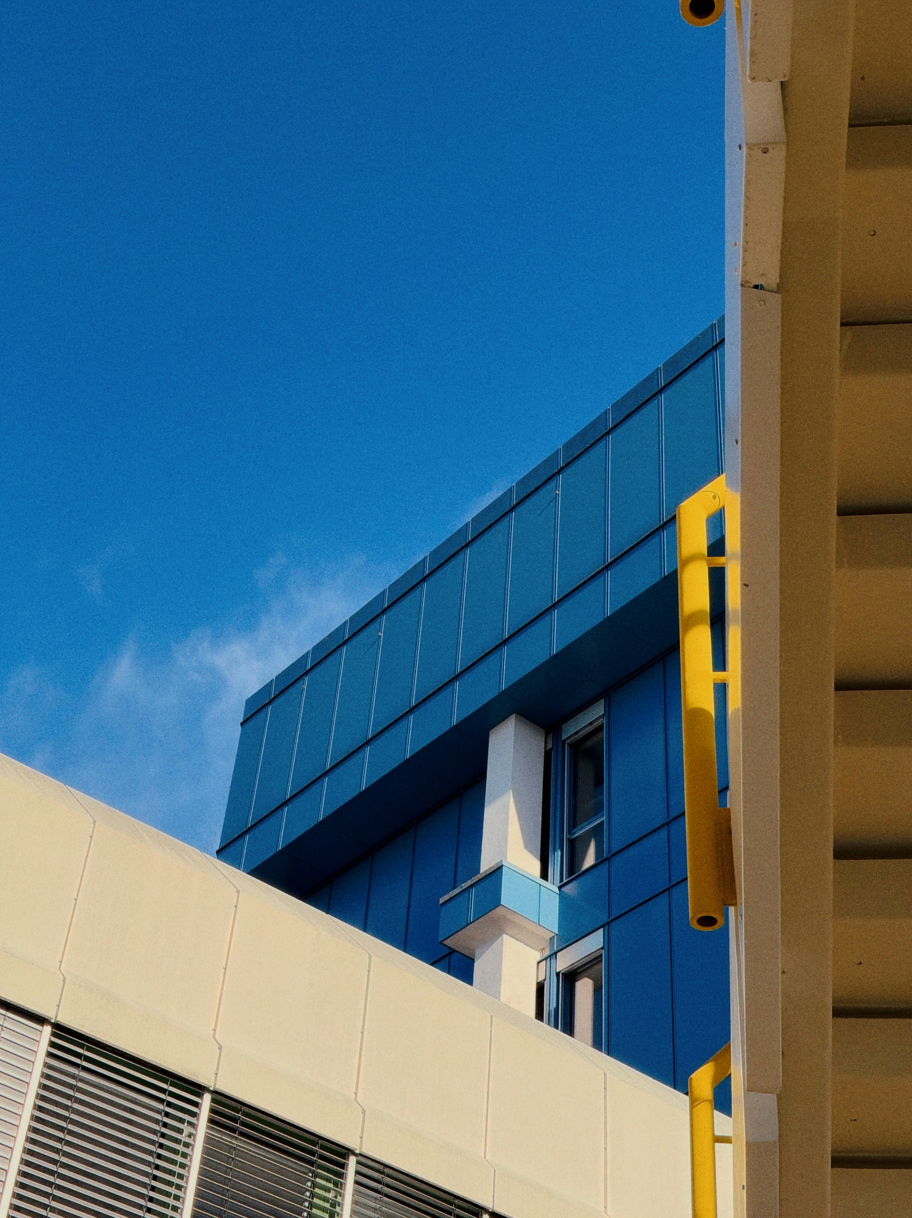 Blue Facade and Yellow Rail Framing at Dusk