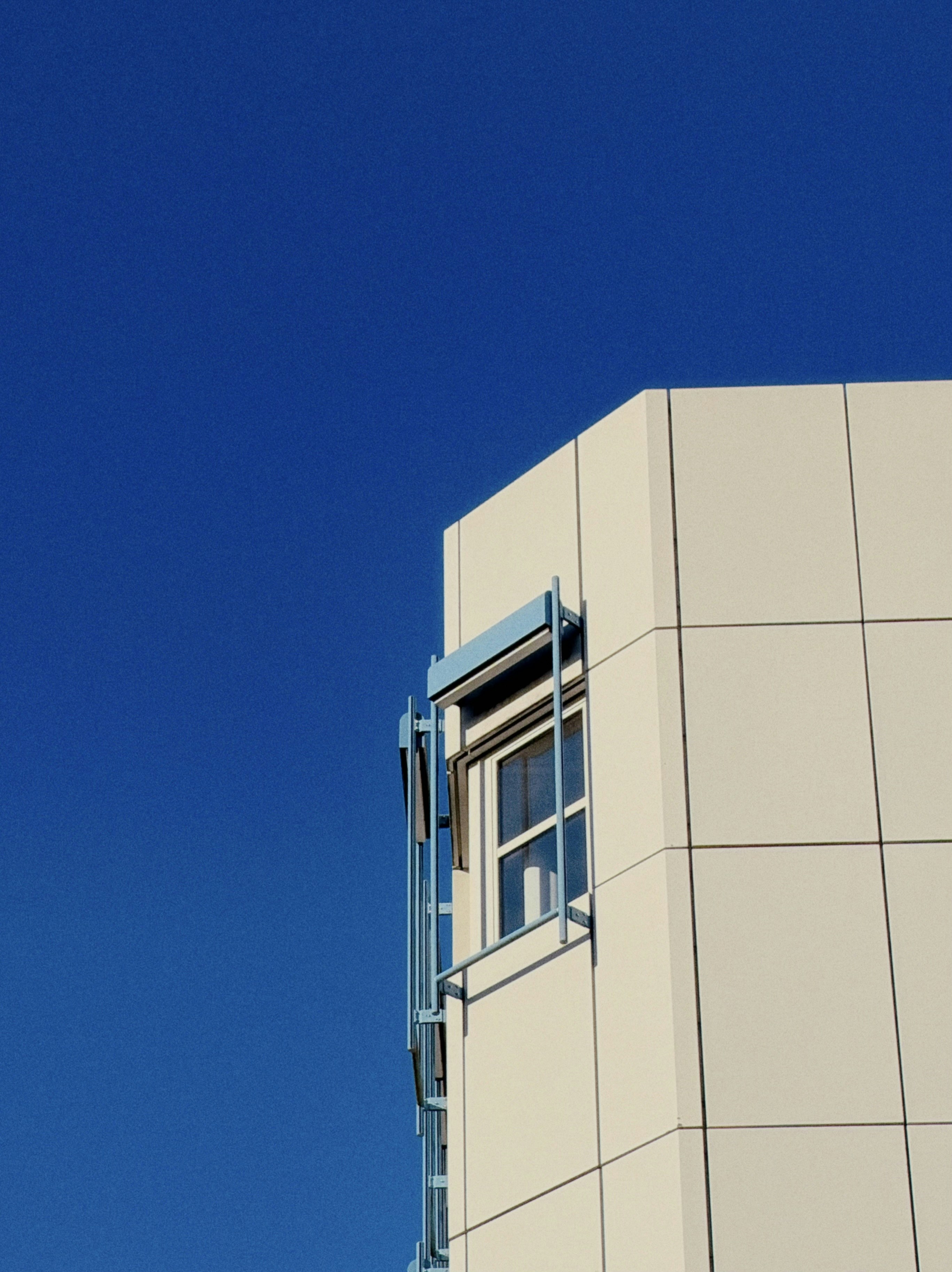 Edge of a Modern Building Reaches into a Vivid Azure Sky