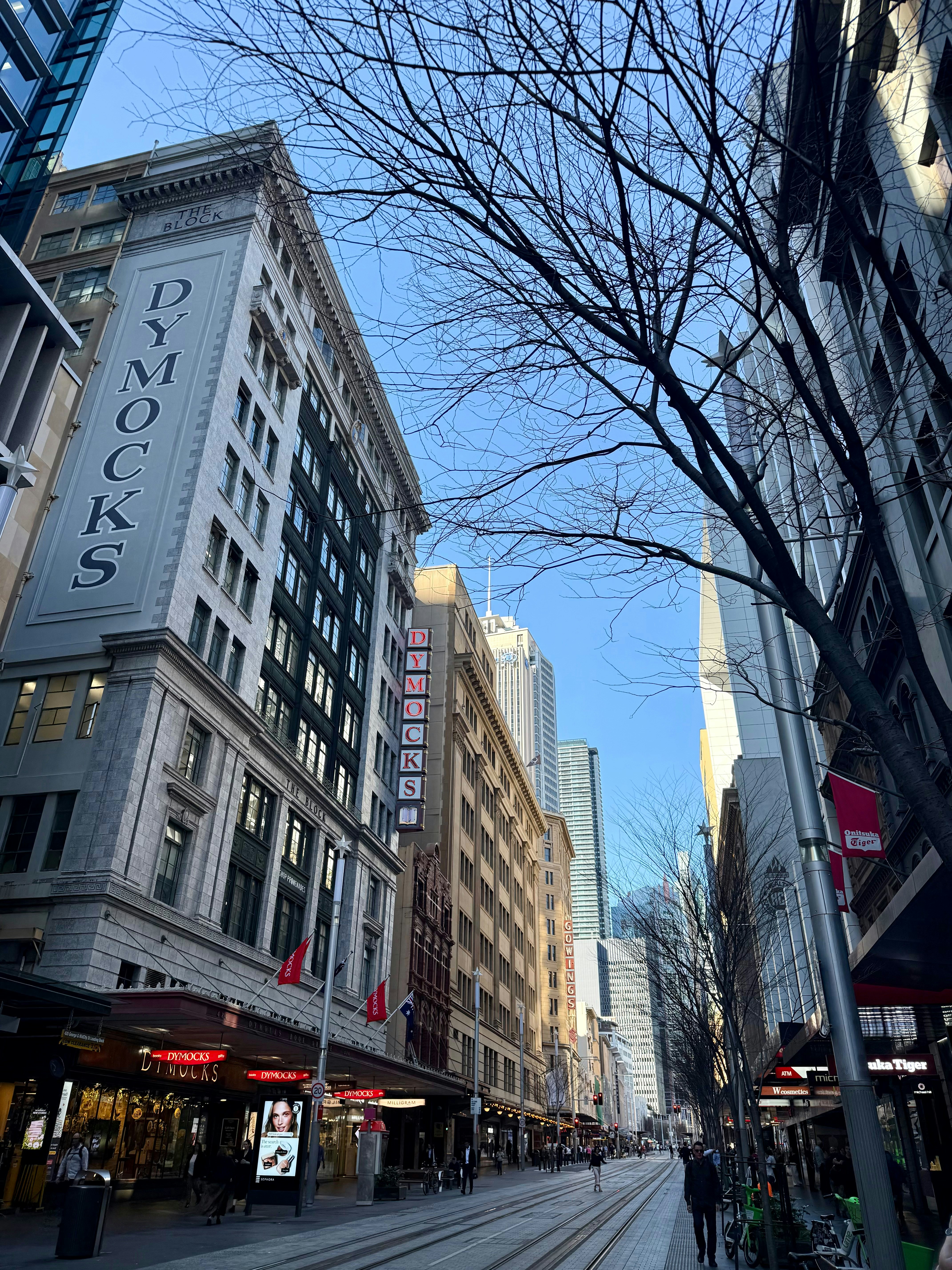 Urban Cascade: A City Street Framed by Historic Dymocks Facade