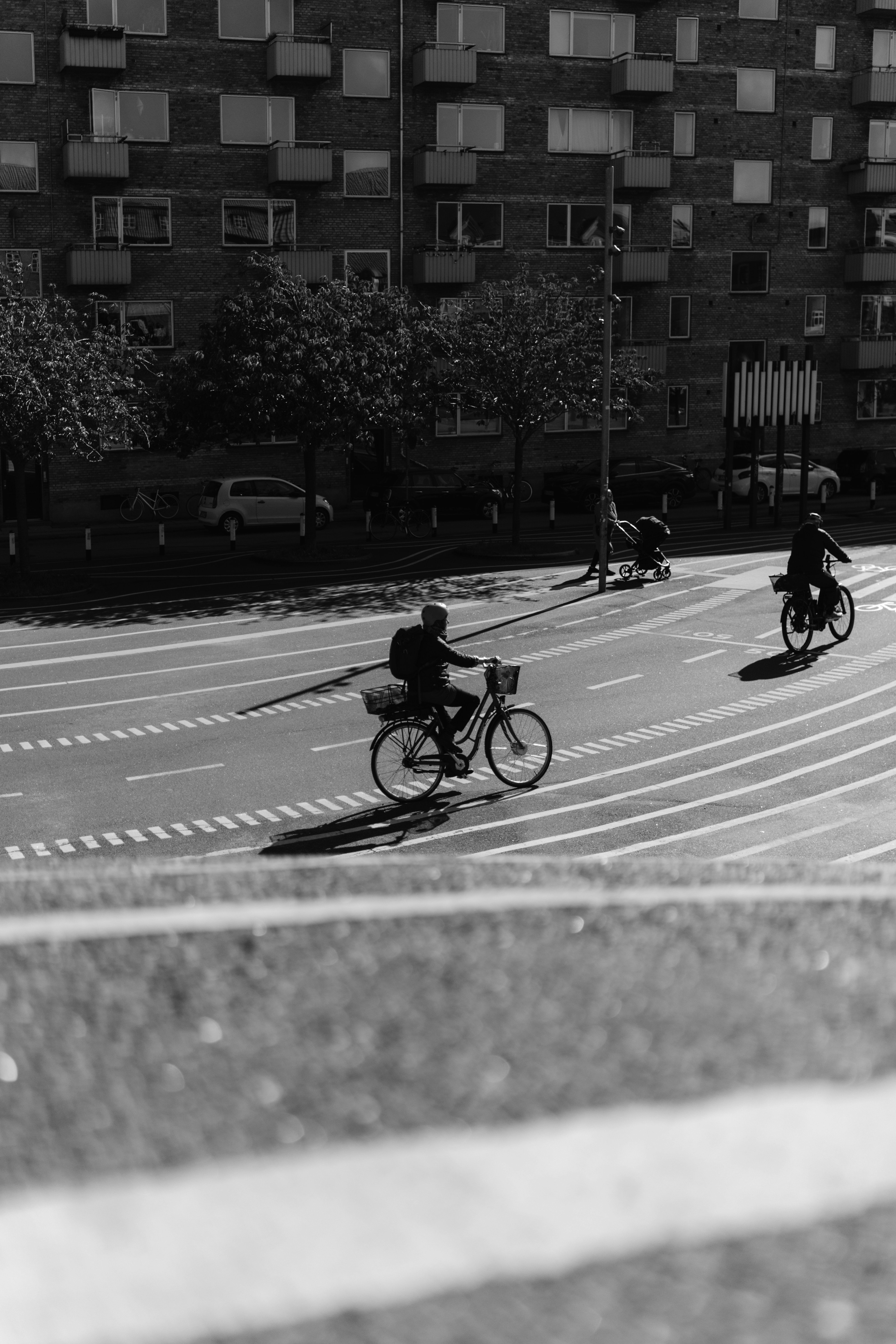 Riders in a Quiet City Sweep Across a Sunlit Street