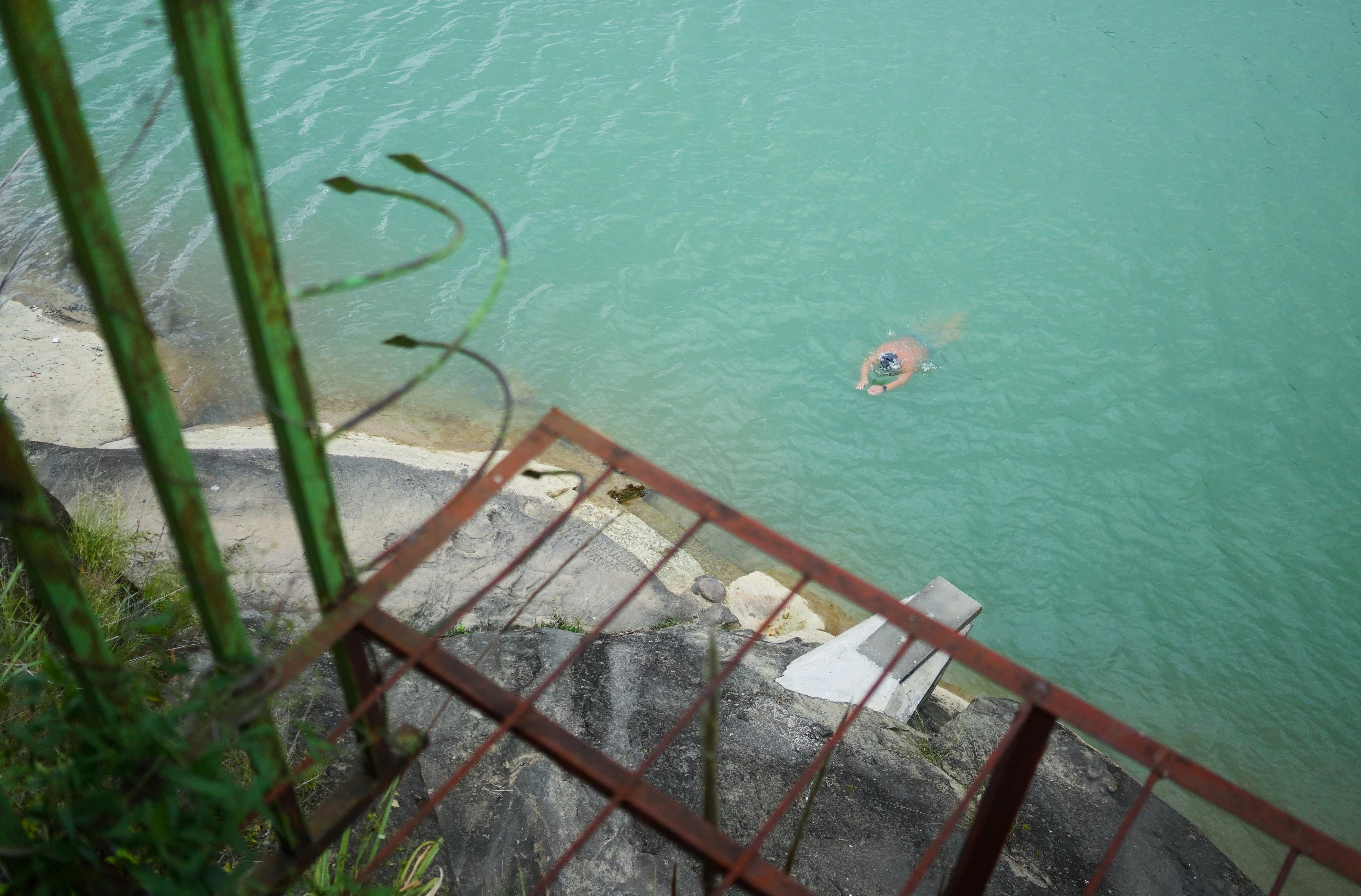 Azure Descent: A Frayed Staircase Looking Over Quiet Water