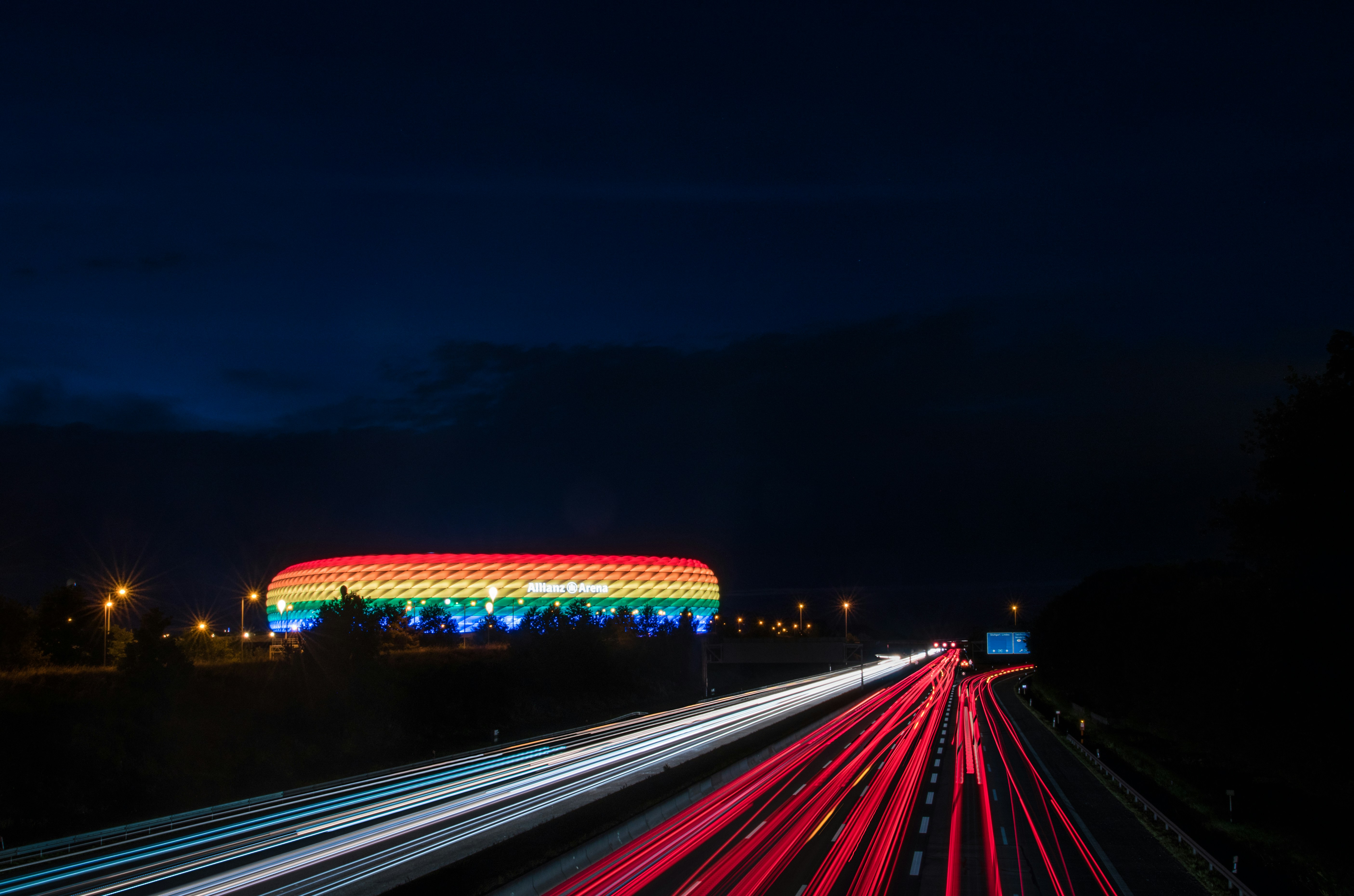 Neon Stadium at Night: A Ribbon of Lights Beneath a Velvet Sky