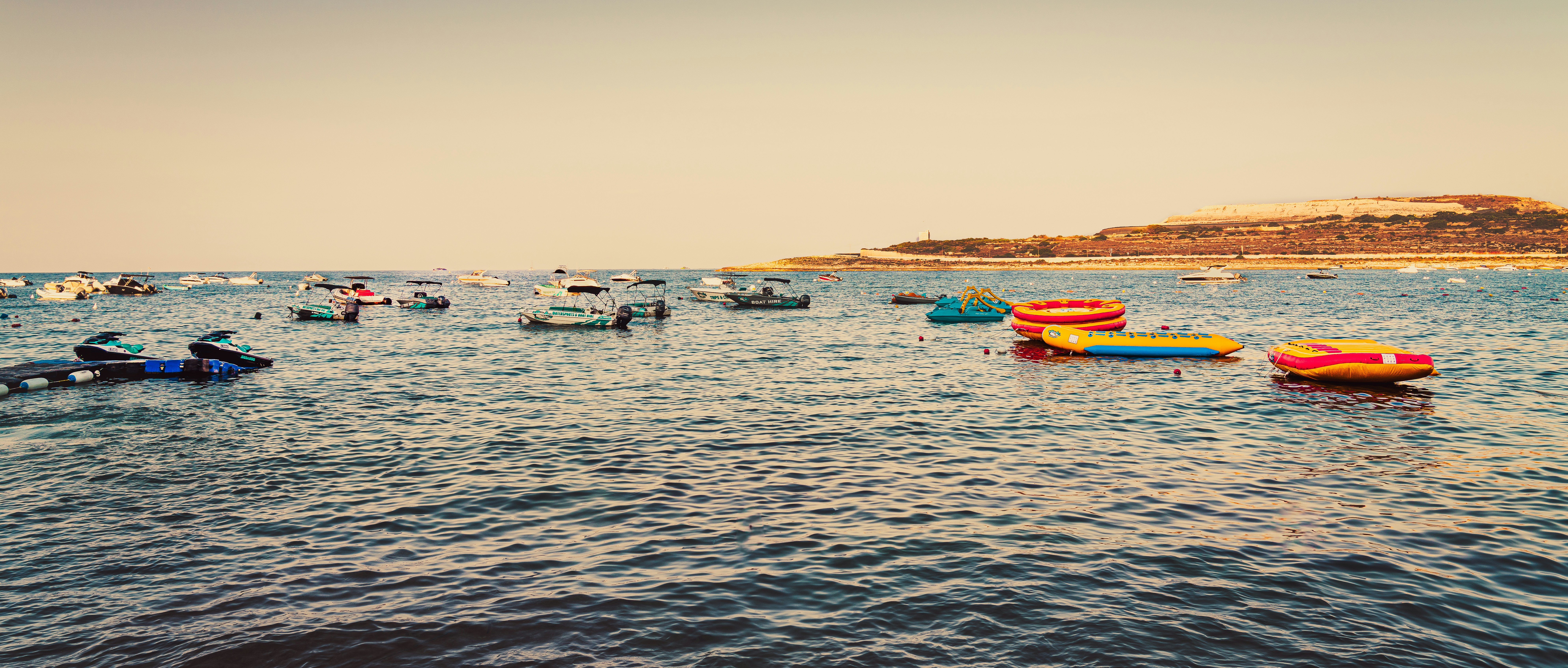 Calm Harbor: Boats Dot the Distant Horizon