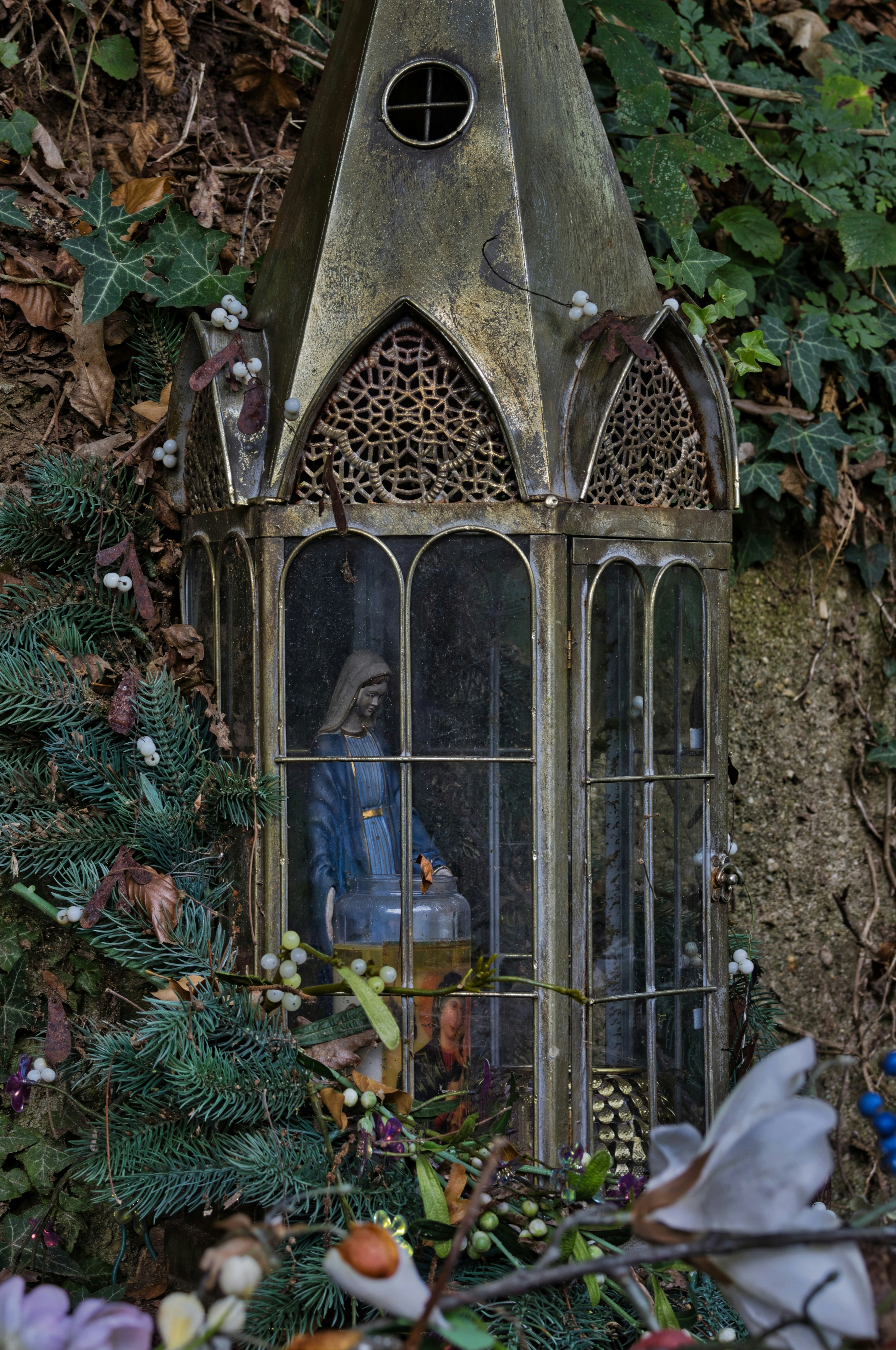 Miniature Shrine of Quiet Decay Buried in Winter Greens