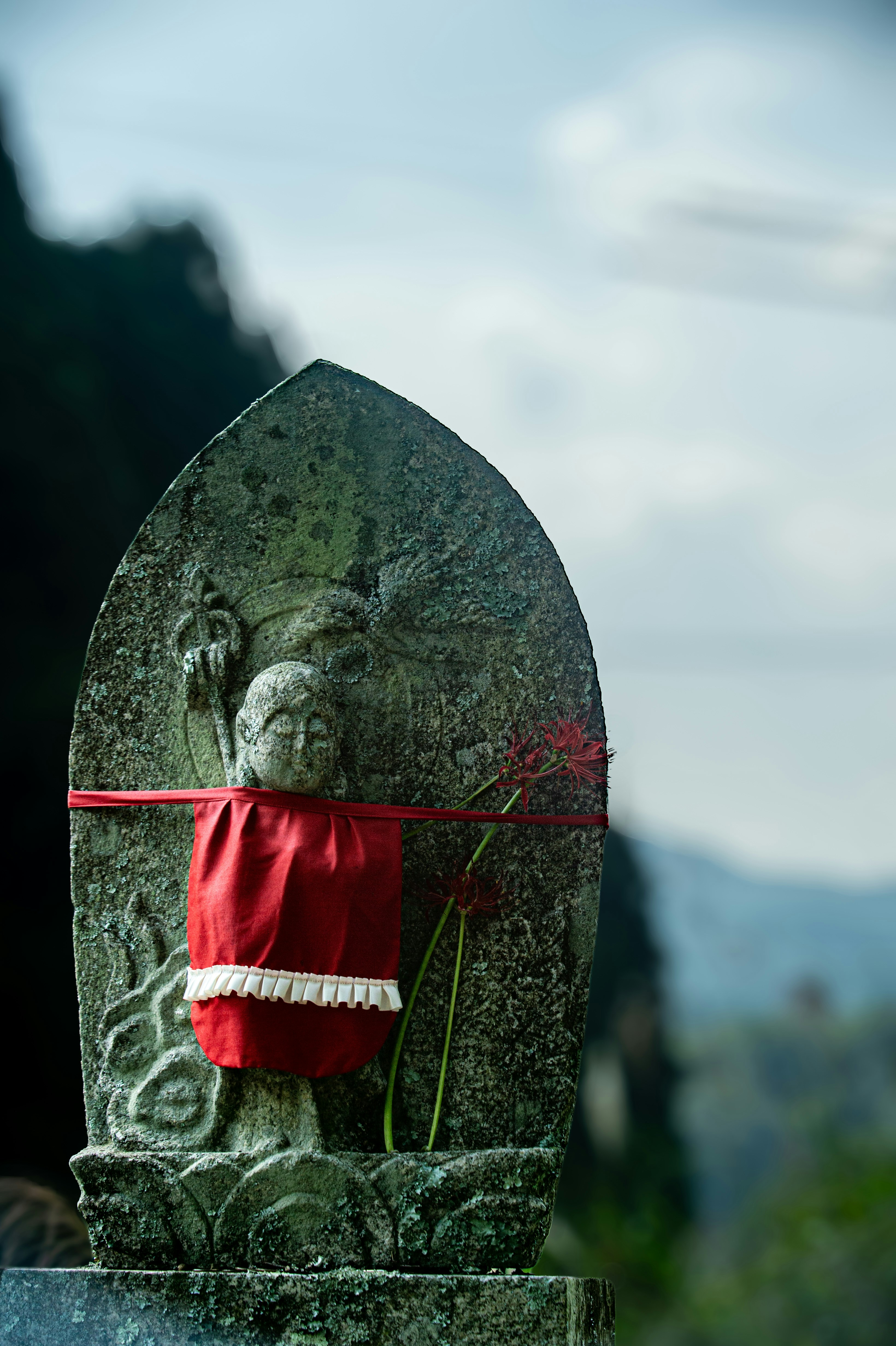Red Ribbon Guardian: A Sacred Stone with a Crimson Veil